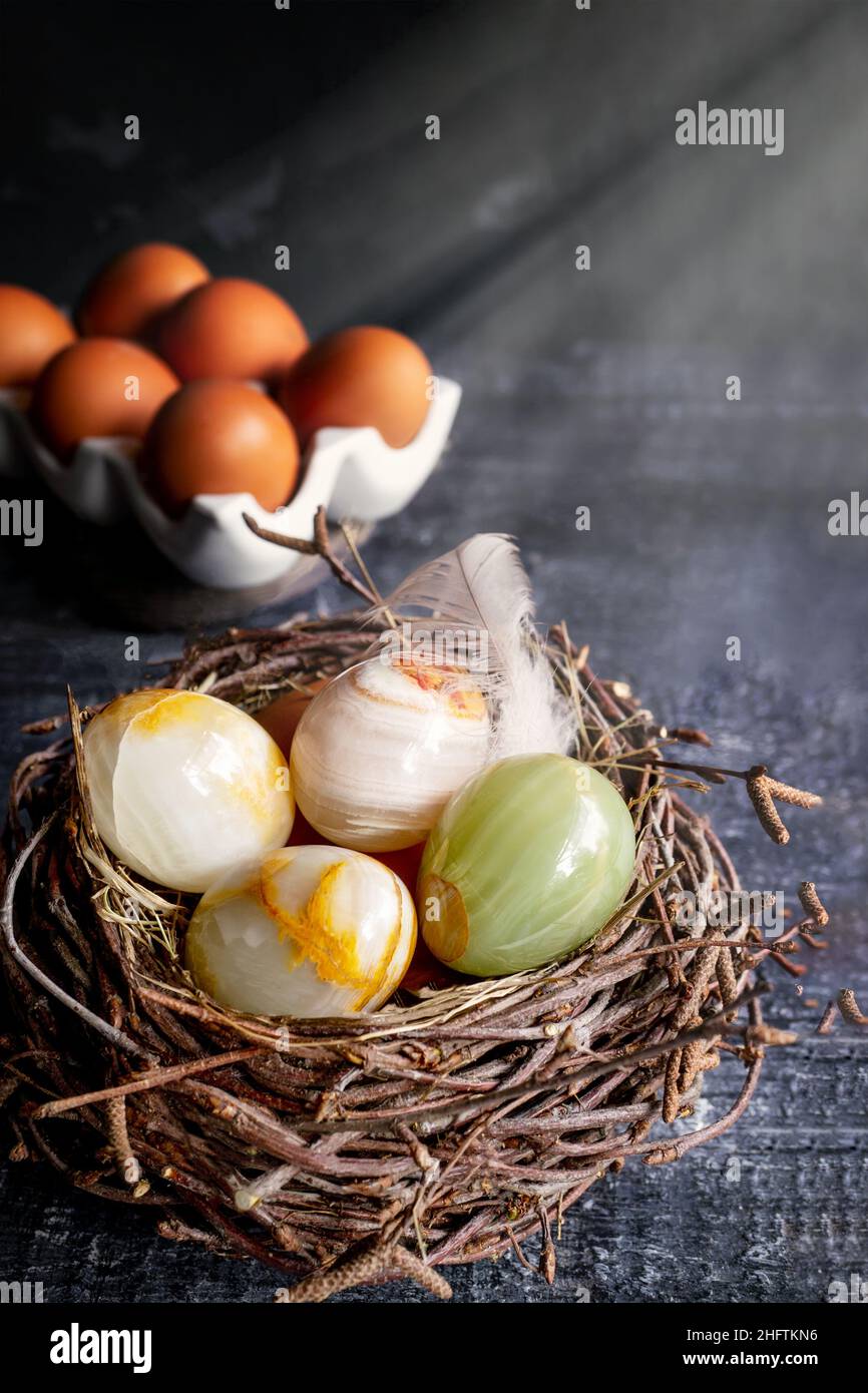 colored onyx spheres in an authentic bird's nest. Easter eggs made of ...