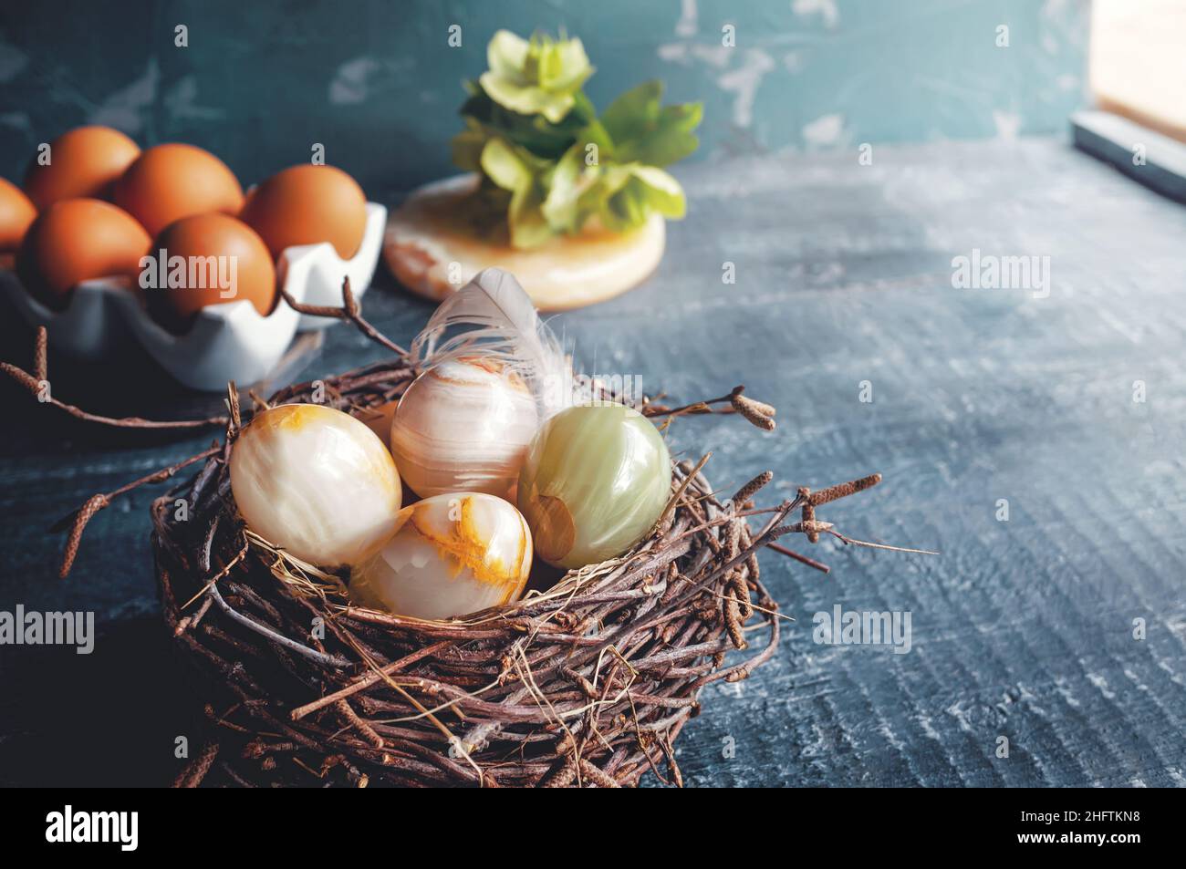 colored onyx spheres in a real bird's nest with natural light from the ...