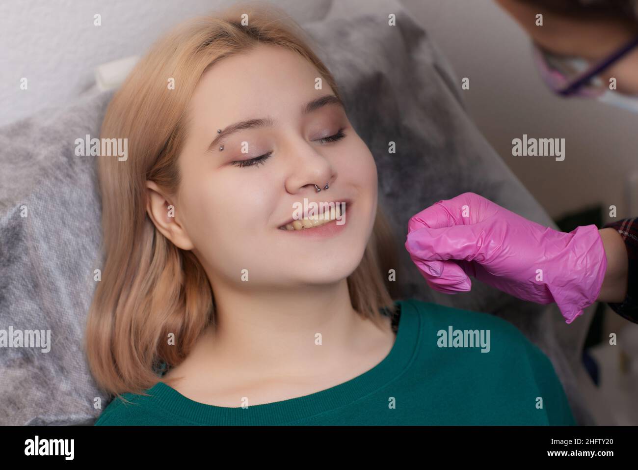 smile or frenulum piercing under the upper lip Stock Photo - Alamy