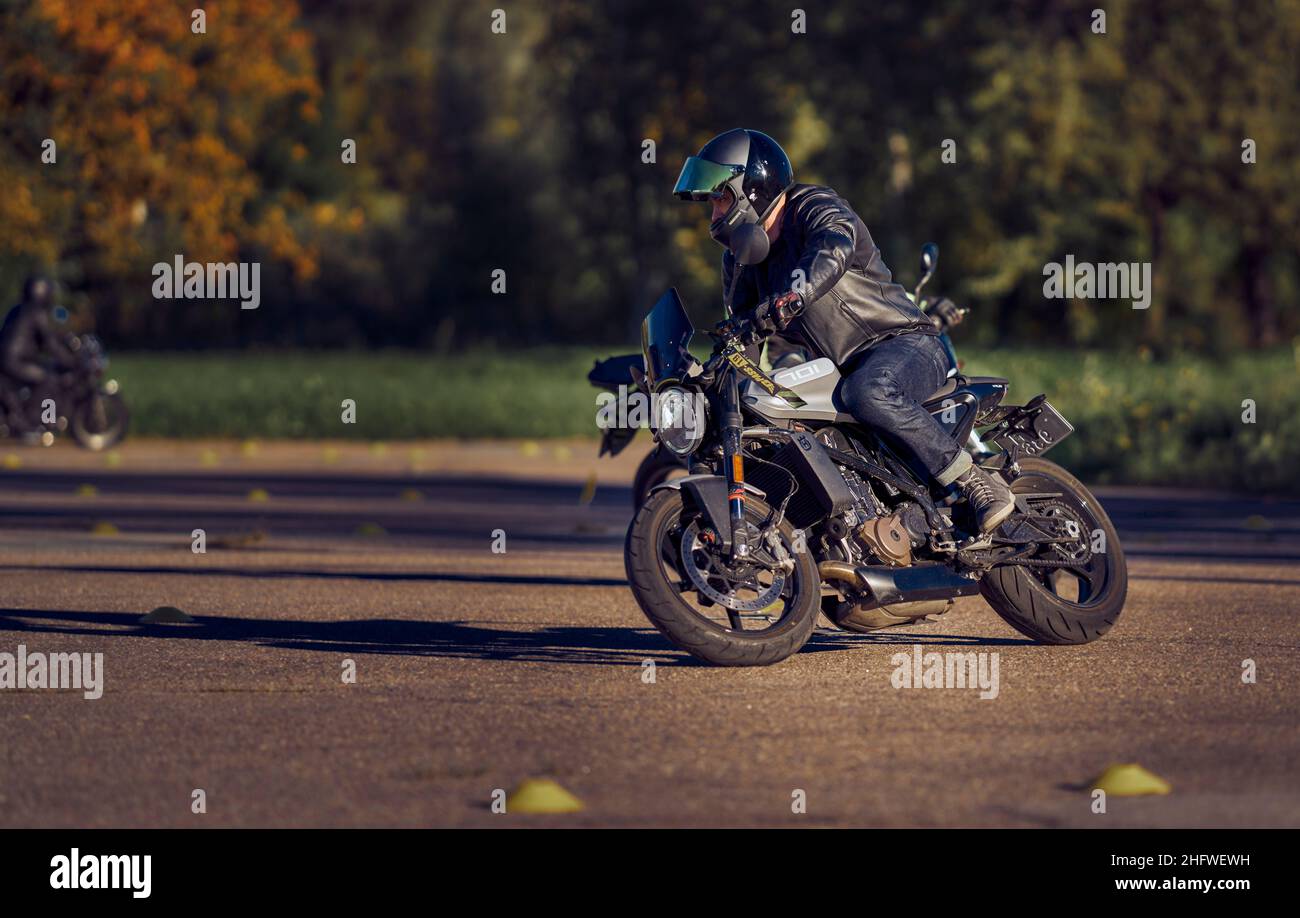 19-09-2021 Riga, Latvia A young man riding a motorcycle on an open road ...