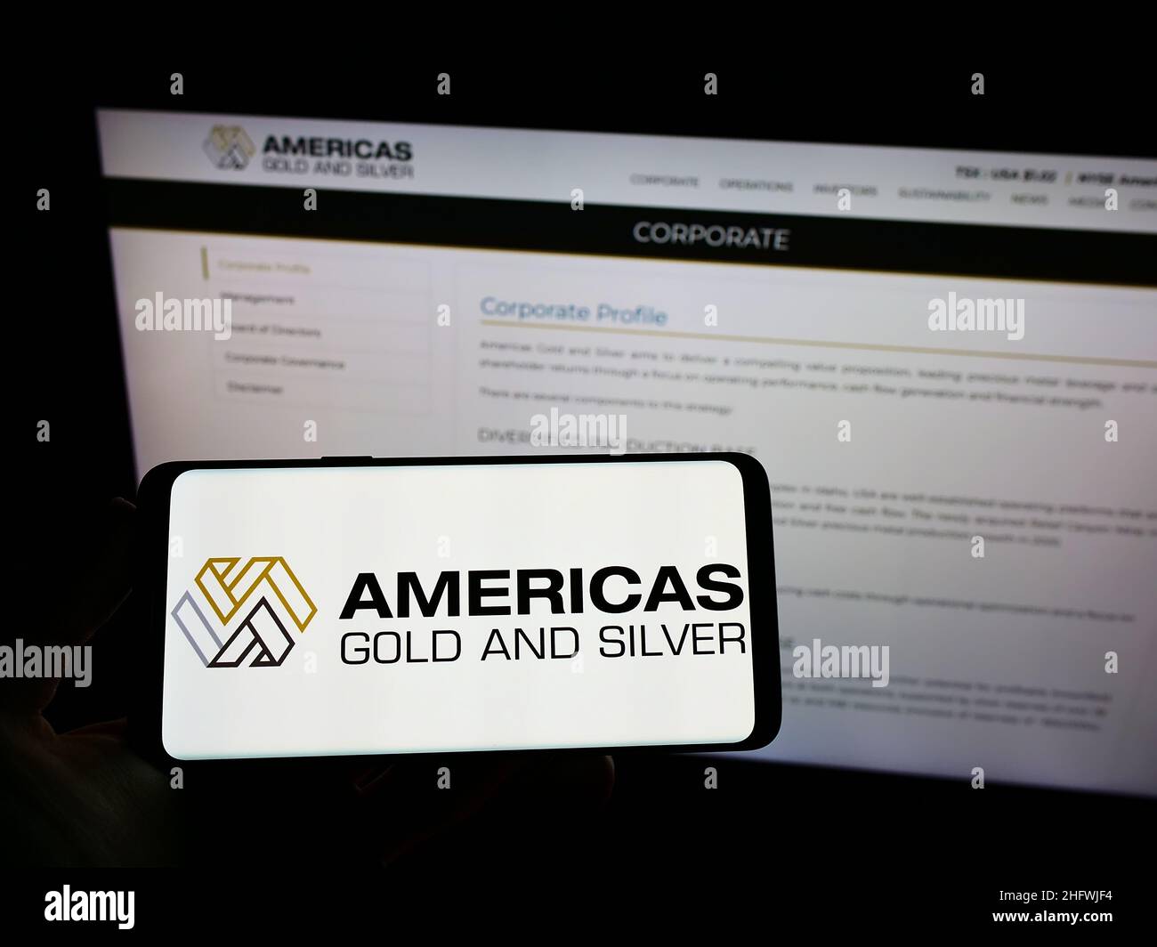 Person holding mobile phone with logo of Canadian company Americas Gold ...