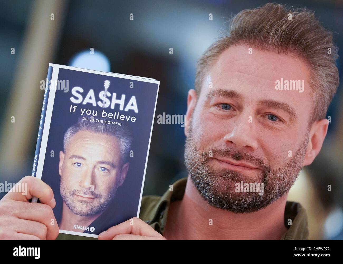 Hamburg, Germany. 17th Jan, 2022. Singer and musician Sasha holds up ...
