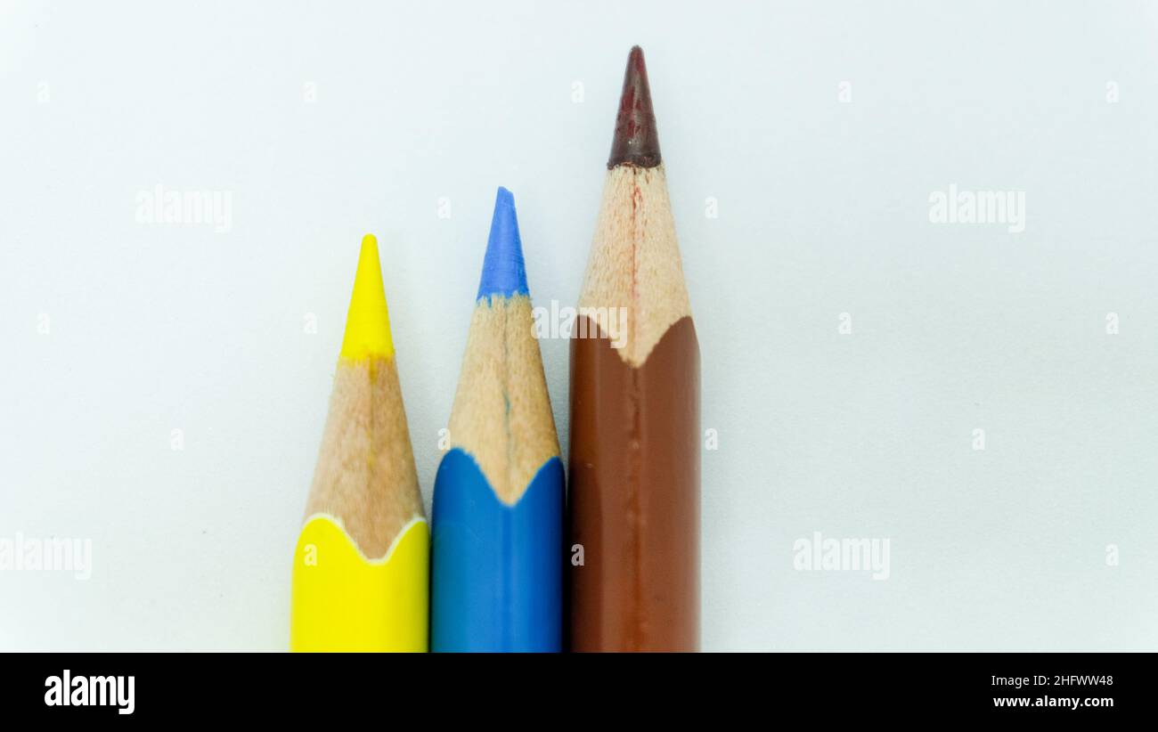 Three color pencils on white background. Isolated close up shot for ...