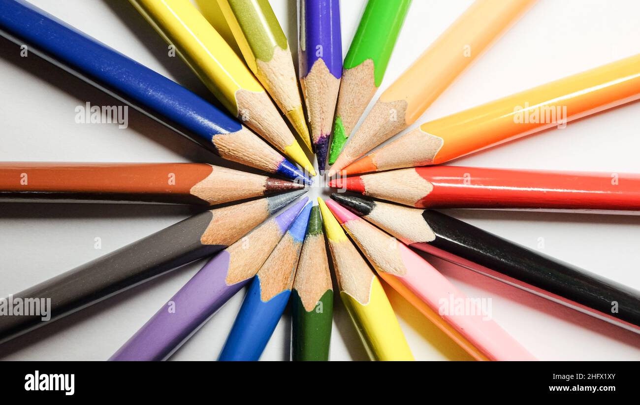 Color pencils converge to form color wheel in white background ...