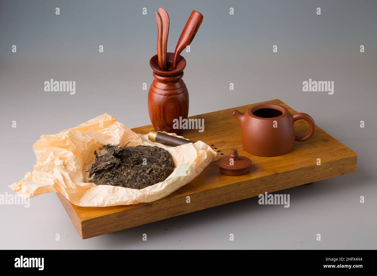 Wooden table for tea ceremonies and a set for brewing tea. Pressed pu ...