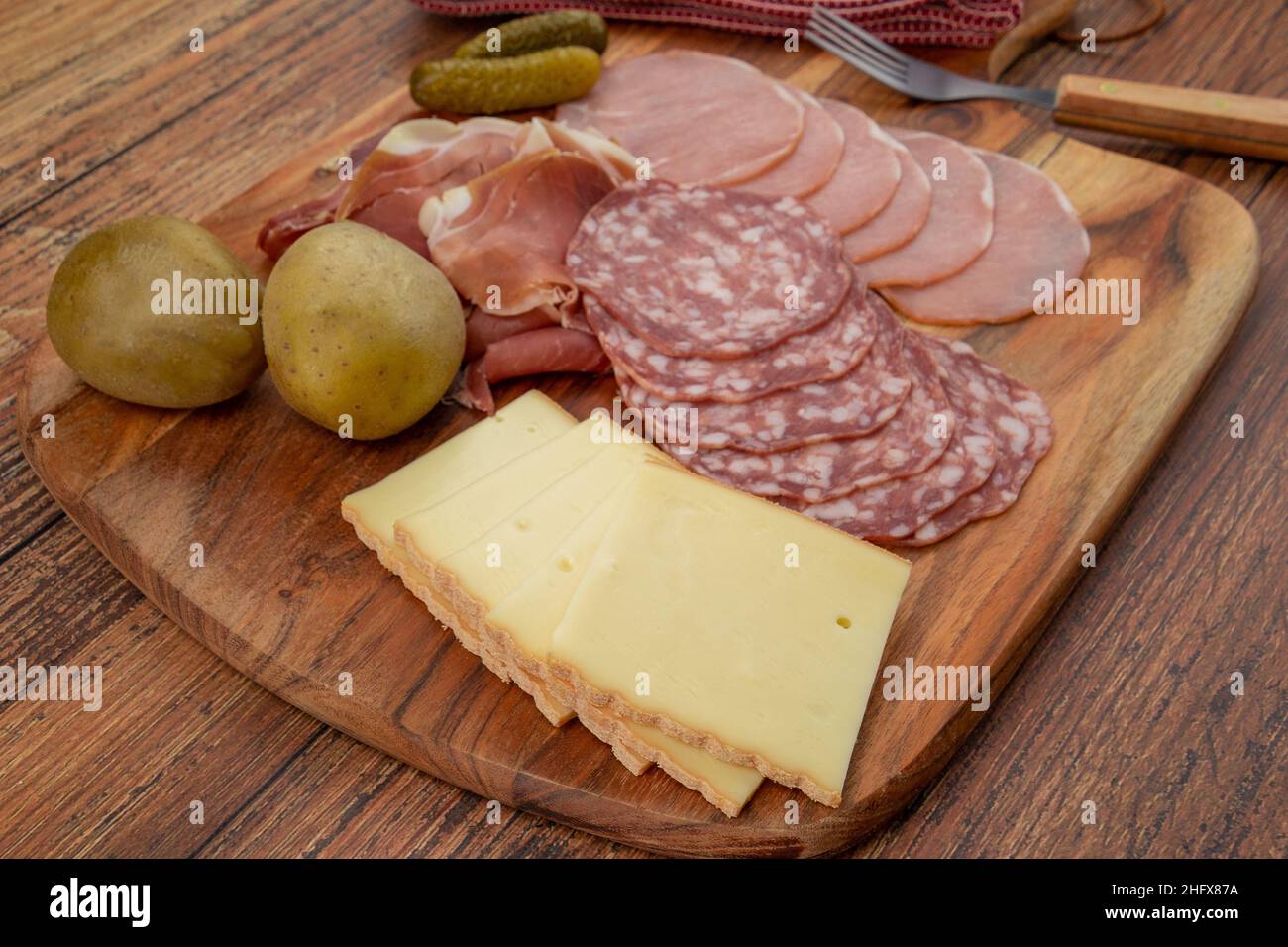 charcuterie and cheese board for a raclette Stock Photo - Alamy