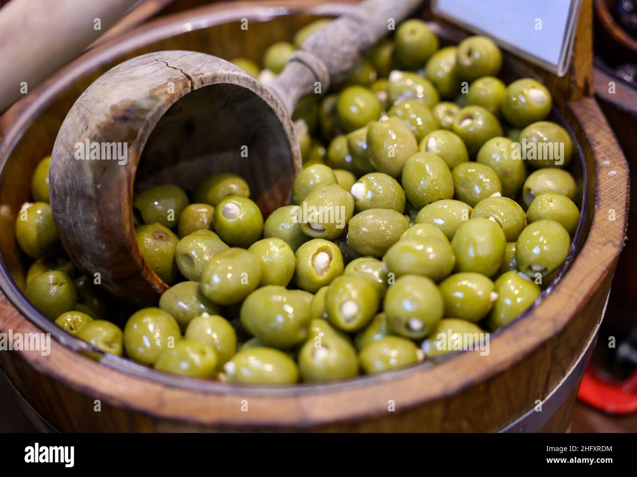 Stuffed green olives in an old wooden bowl Stock Photo - Alamy