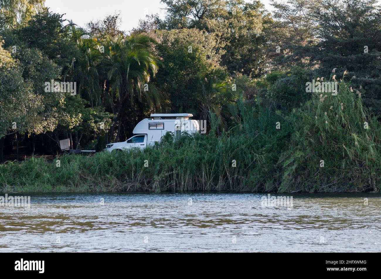 Camper van stands on the banks of the Okavango River, Namibia, Africa ...