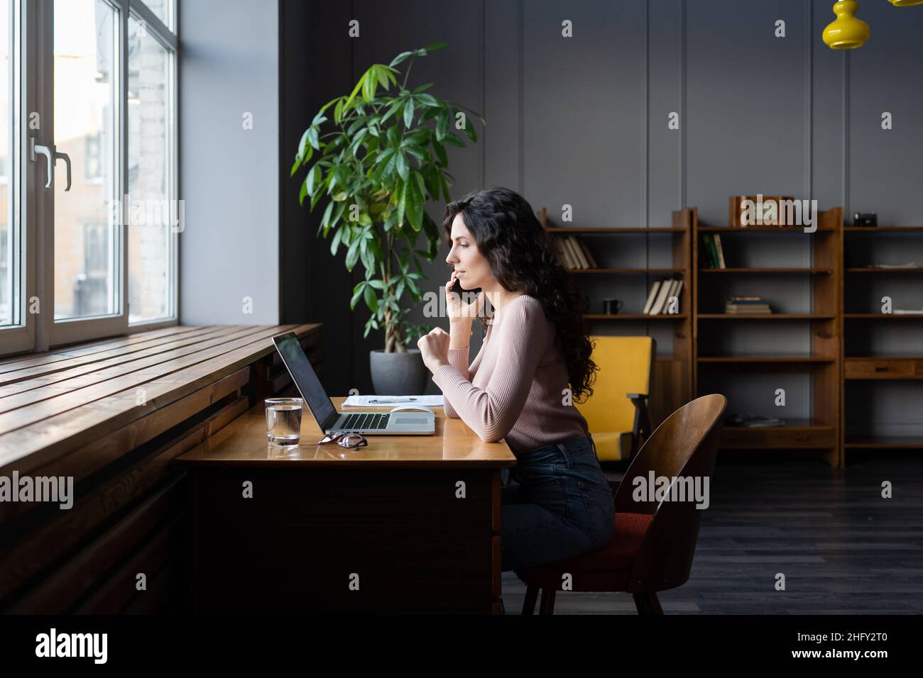 Female entrepreneur works cellphone laptop hi-res stock photography and ...