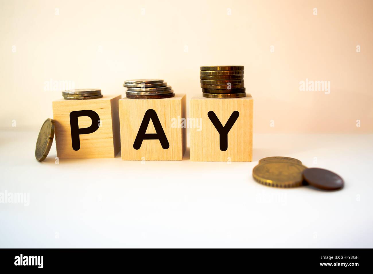 Hand is turning a dice and changes the word Pay to Day Stock Photo - Alamy