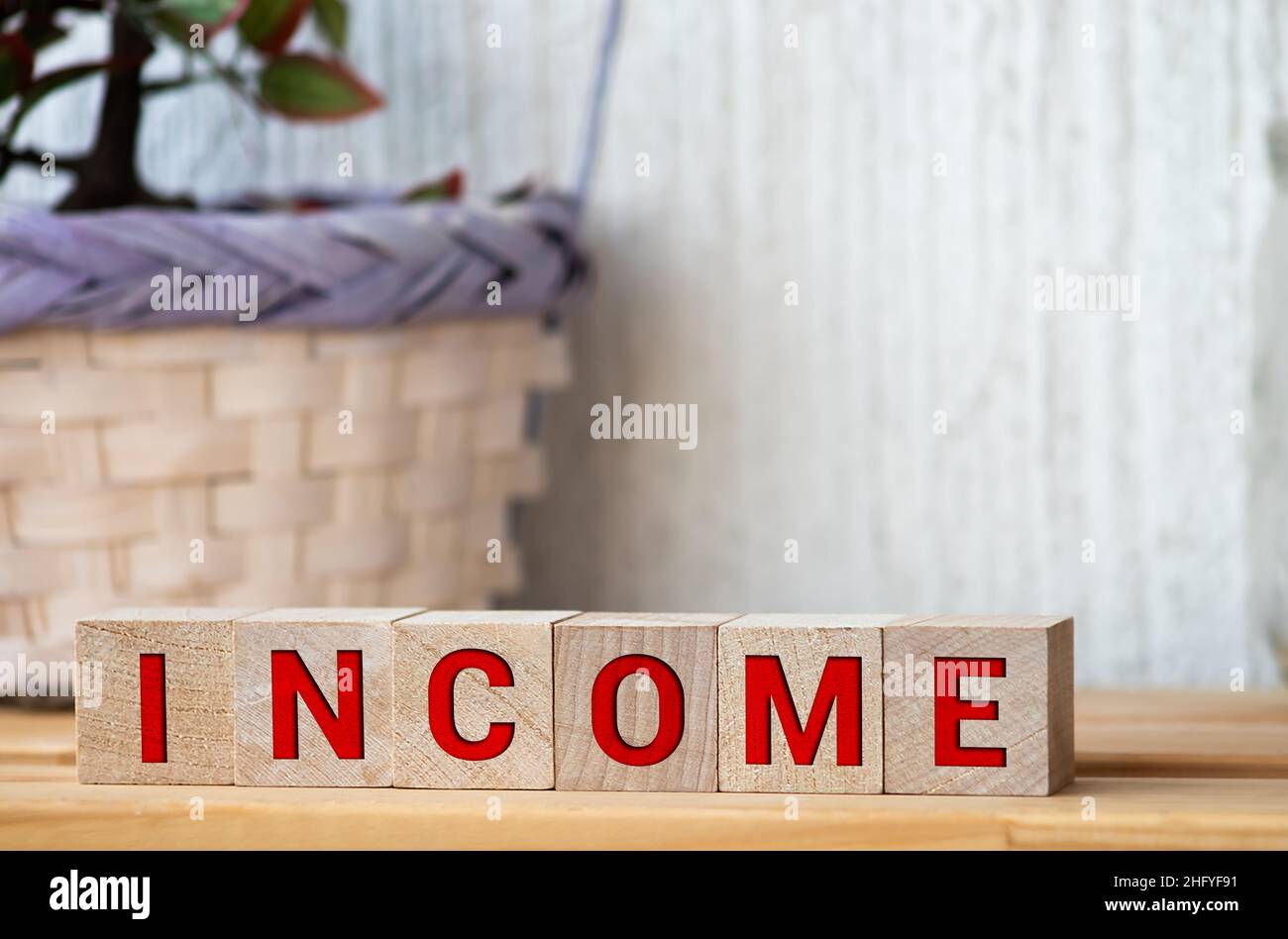 INCOME text written on wooden block with stacked coins isolated on ...
