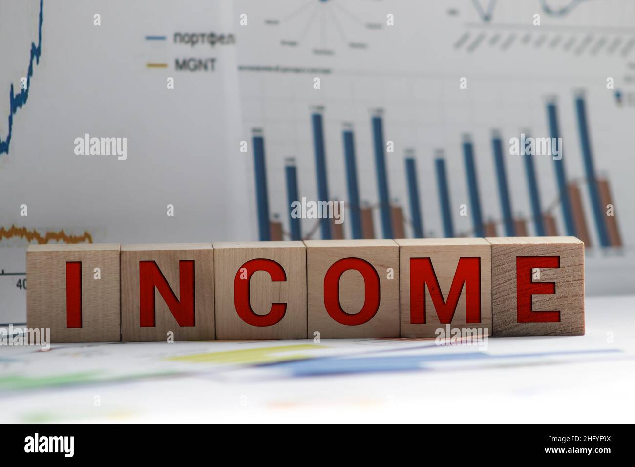 INCOME text written on wooden block with stacked coins isolated on ...