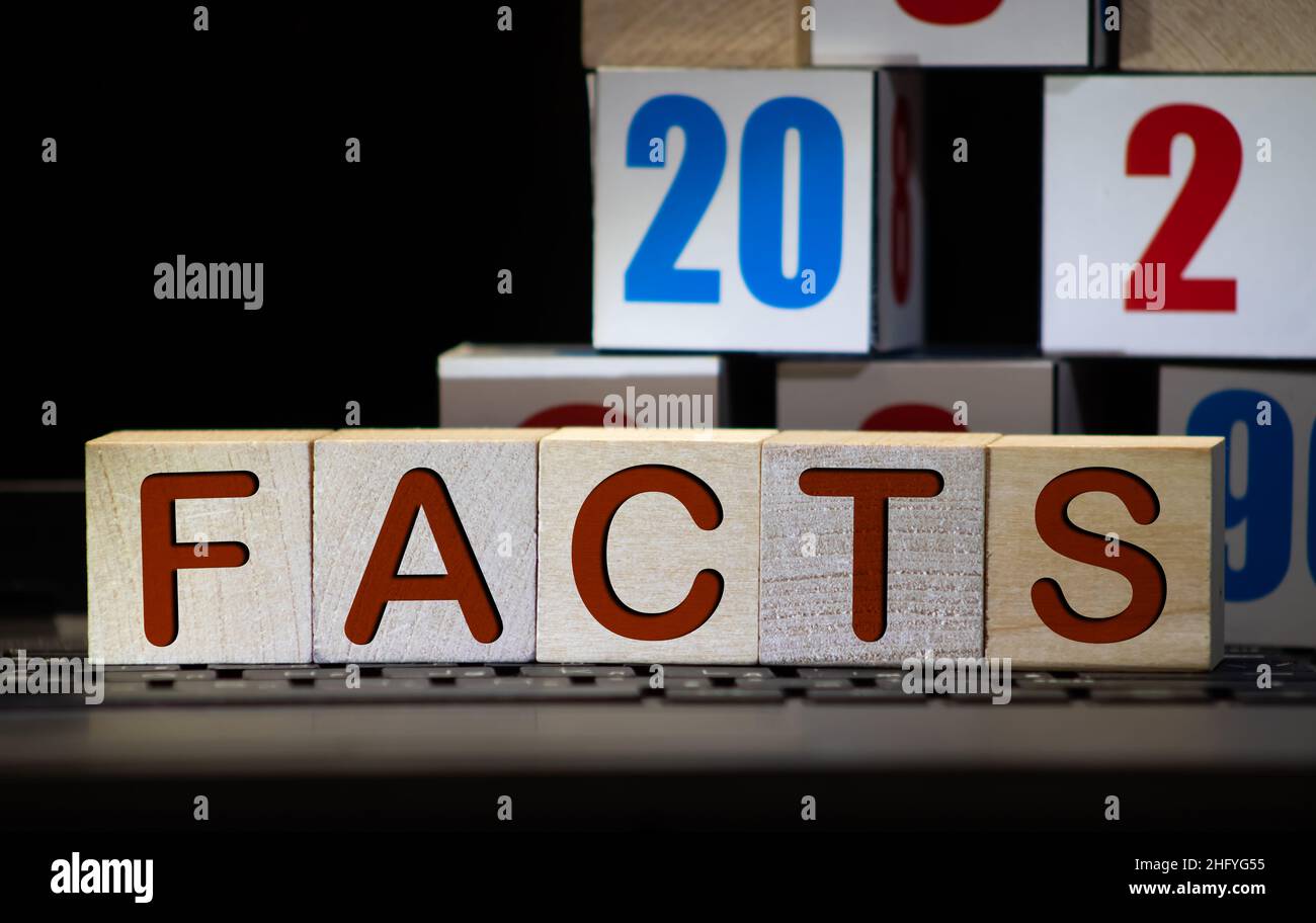 facts word written on wood blocks beige background Stock Photo - Alamy