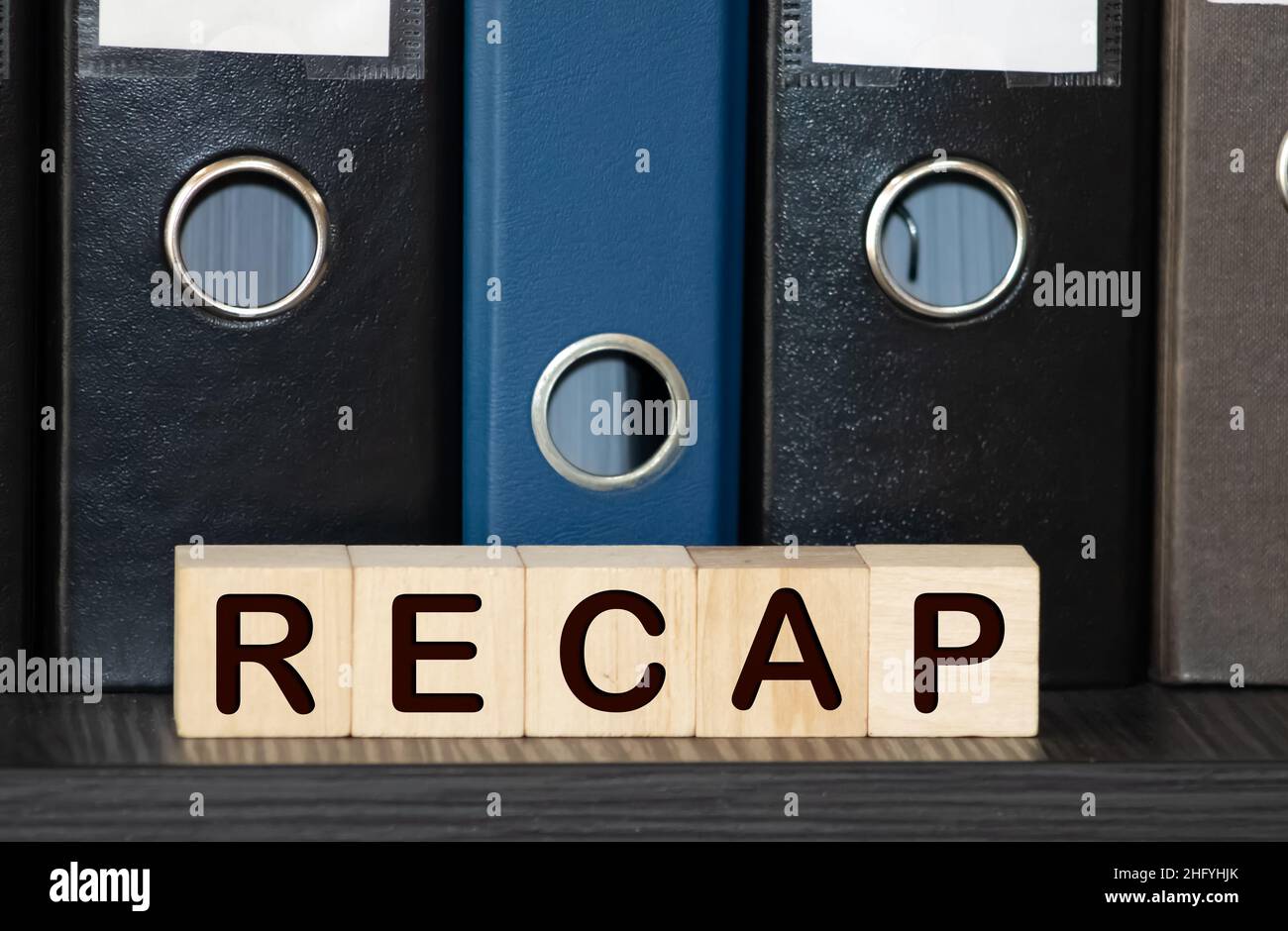 Recap word from wooden blocks on desk Stock Photo - Alamy