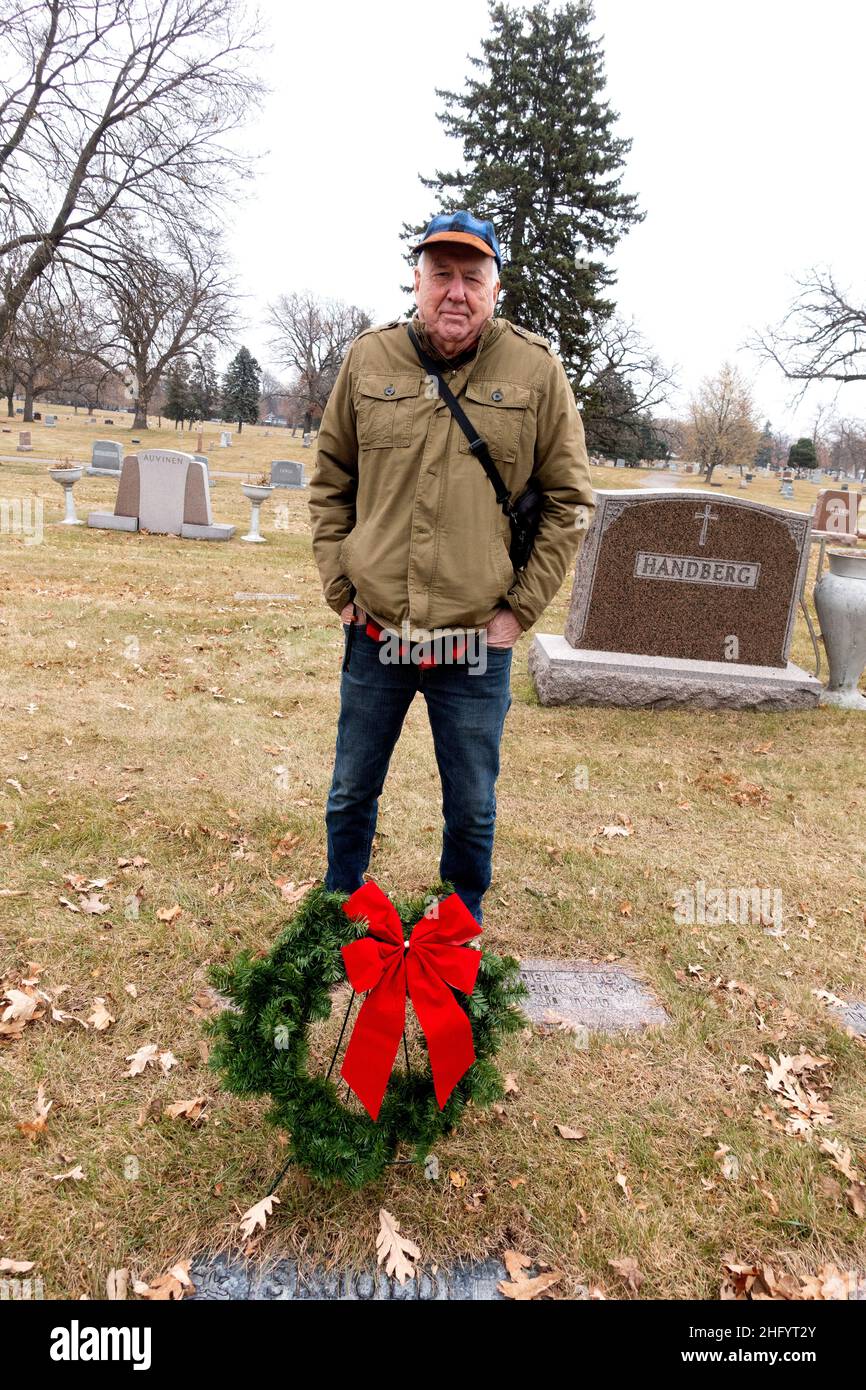 Photographer Steve Skjold placing a wreath at parent's grave at the ...
