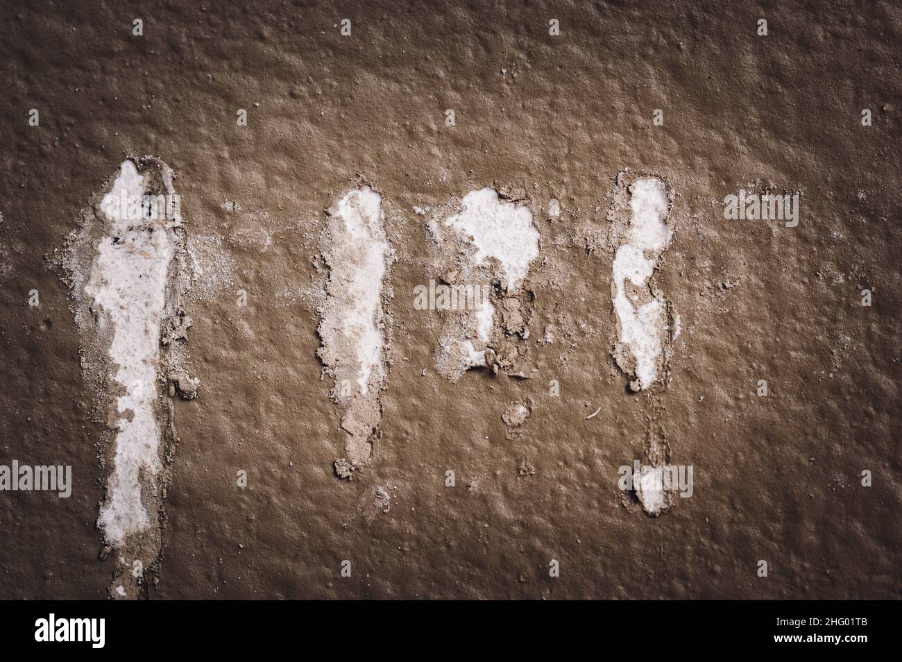 Series of scratches and dents in drywall where the paint as been ...