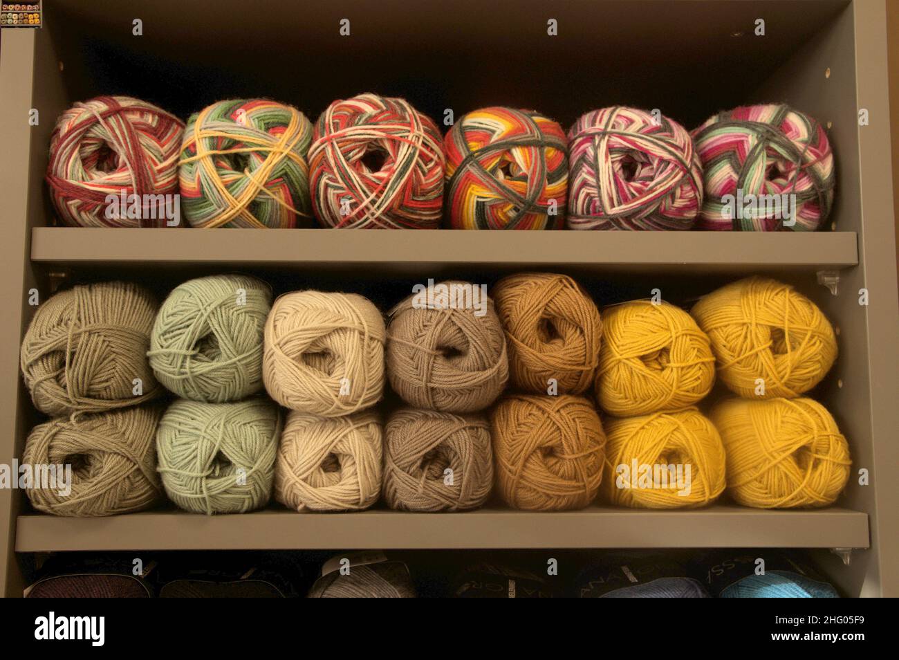 Colourful balls of wool on shelves Stock Photo - Alamy
