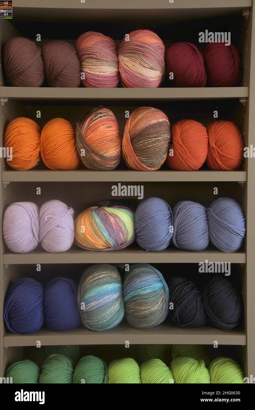 Colourful balls of wool on shelves Stock Photo - Alamy