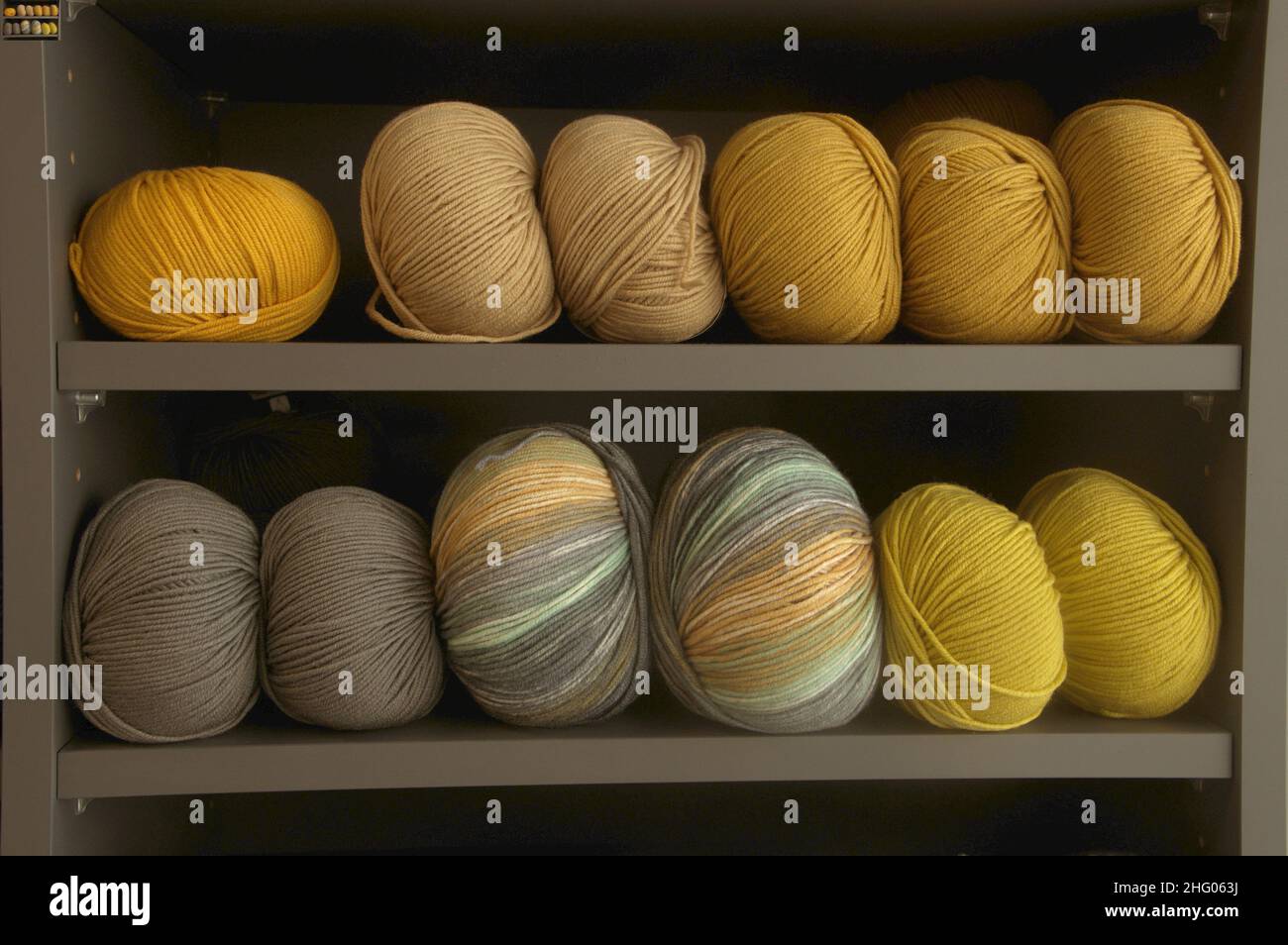 Colourful balls of wool on shelves Stock Photo - Alamy