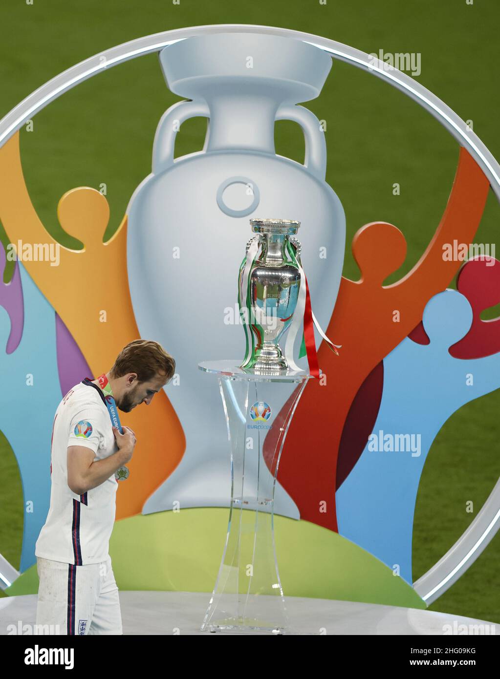 England's Harry Kane walks past the trophy after receiving his runner ...