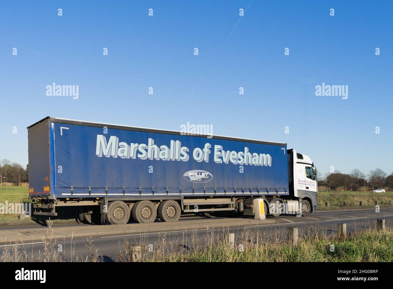 rear side view of Marshalls of Evesham HGV lorry in dark blue canvas ...