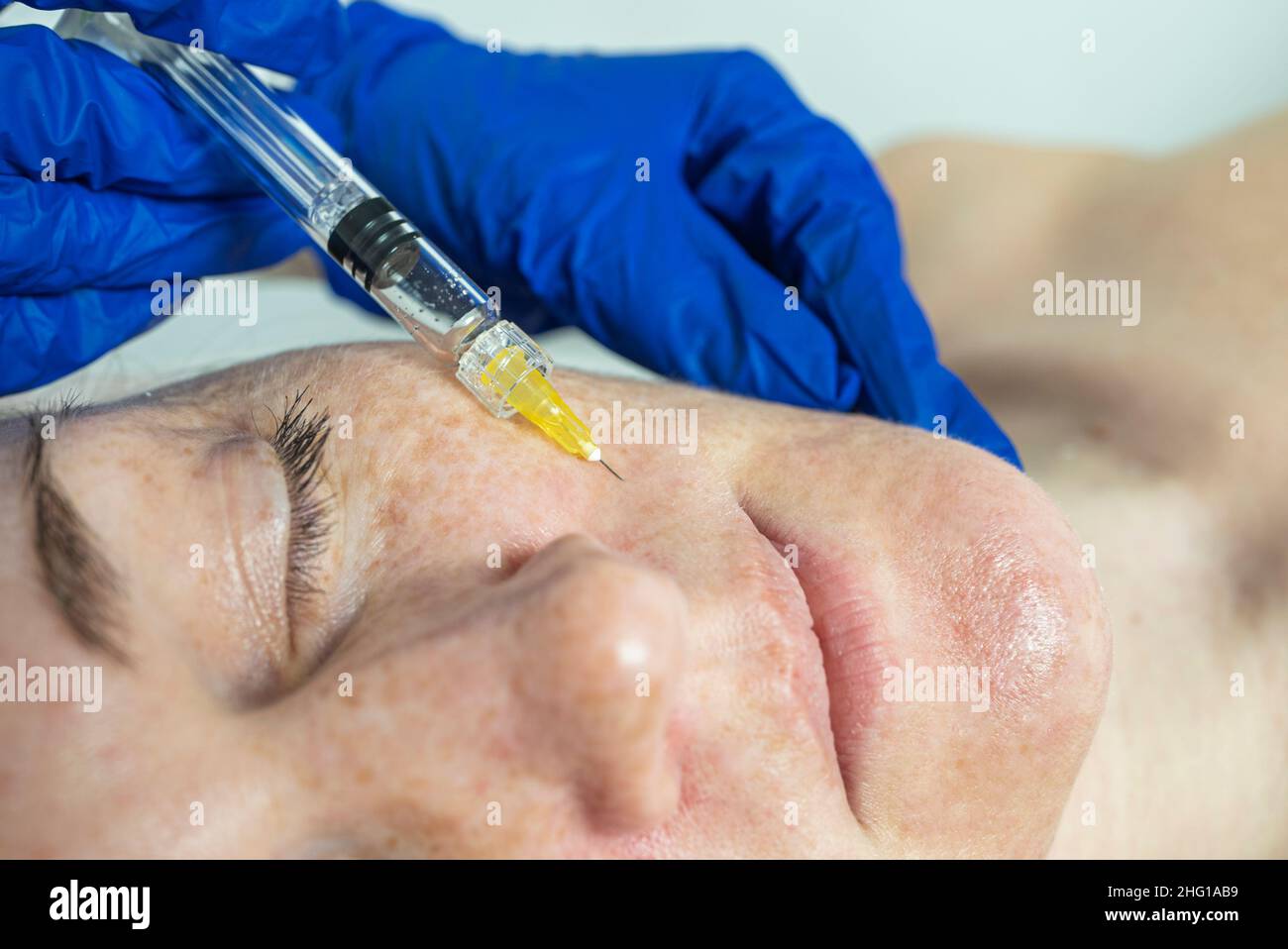 Close-up of a cropped image of a doctor's hands doing facial ...