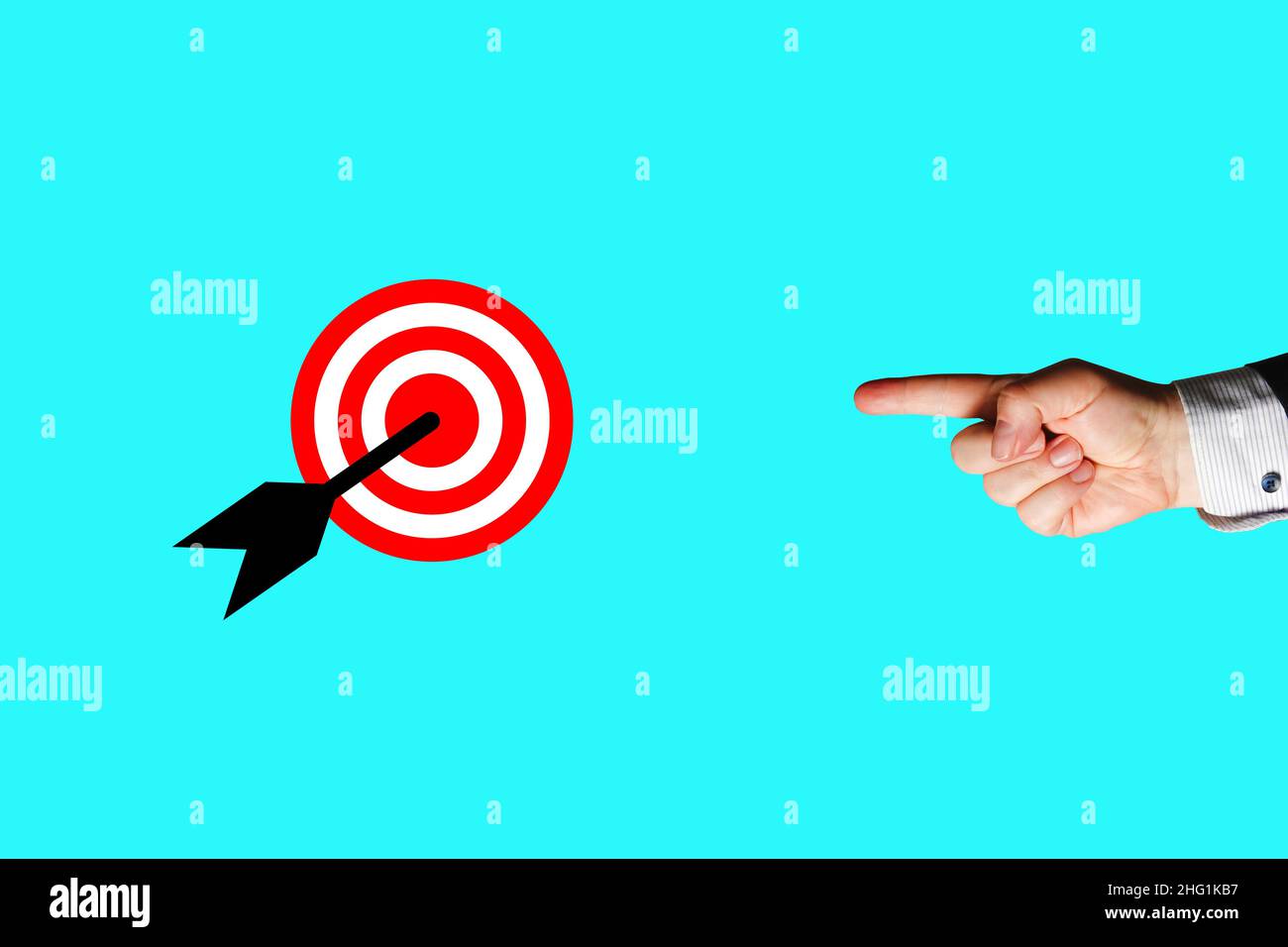 Hand and a finger pointing at a target (bullseye), symbolizing ...