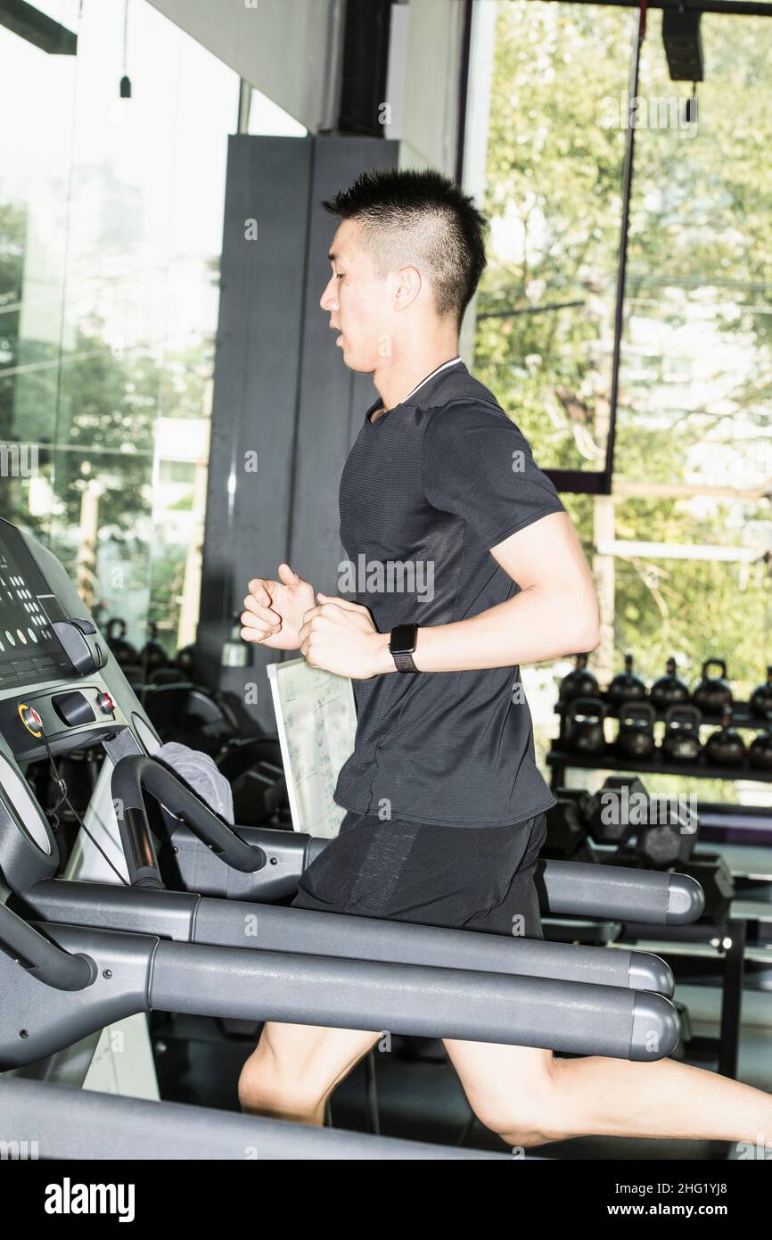 man running on treadmill at gym in Bangkok Stock Photo - Alamy