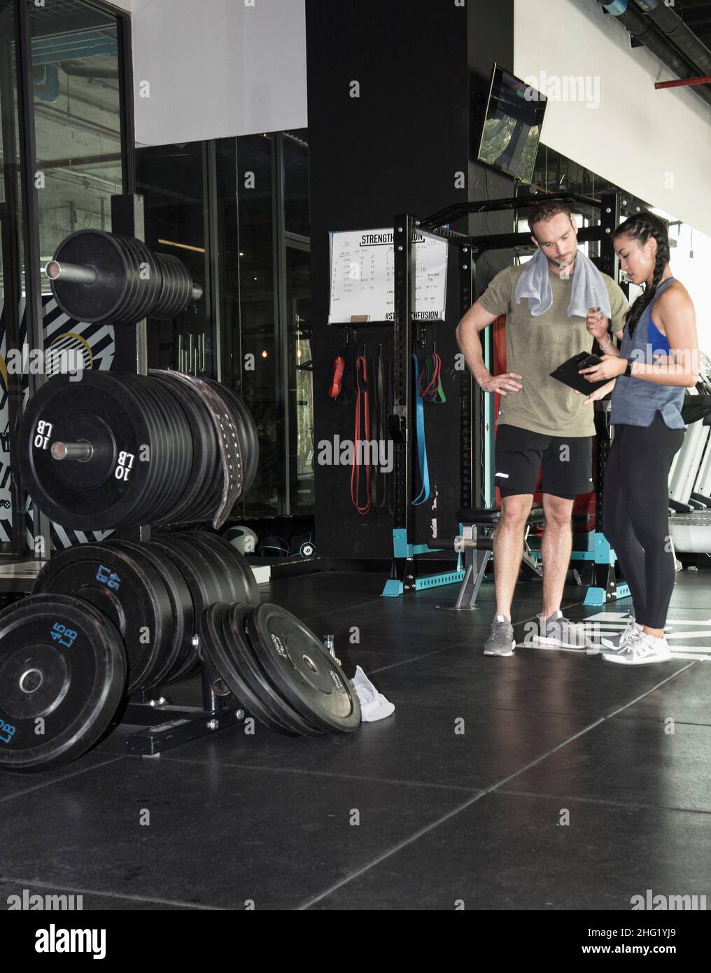 woman recording her progress at gym in Bangkok Stock Photo - Alamy