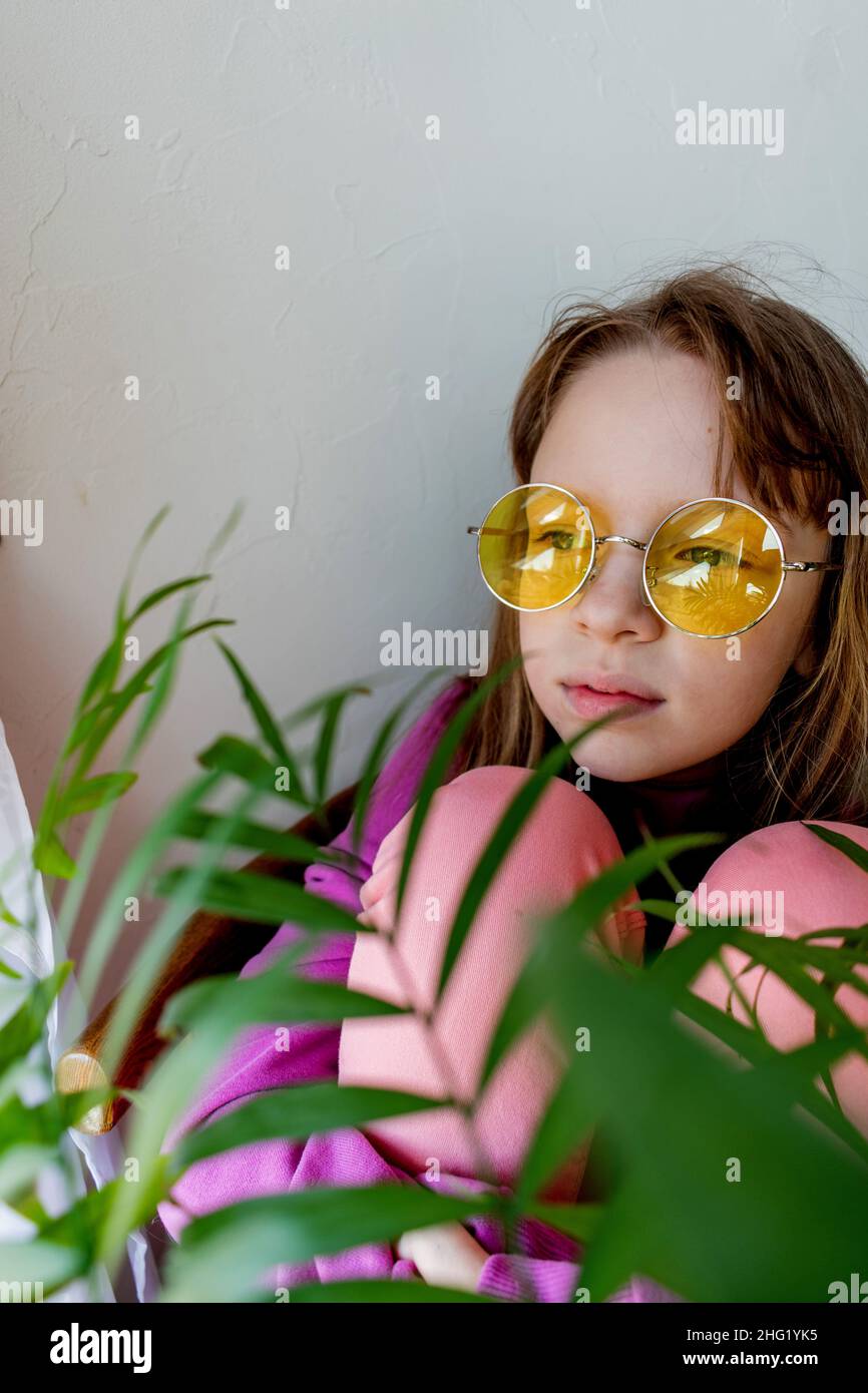 Teenager girl looks out the window. Hard light. Shadow Stock Photo - Alamy