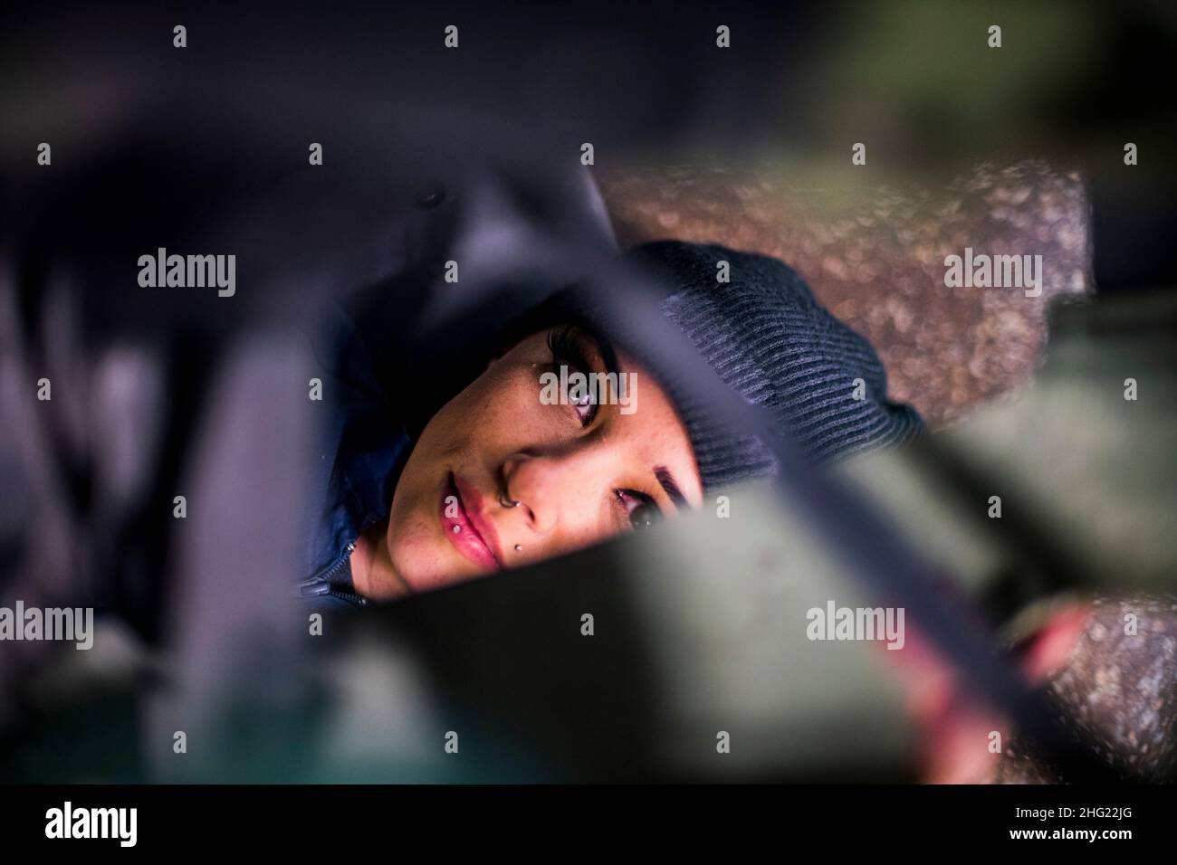 Female Auto worker portrait below car Stock Photo - Alamy