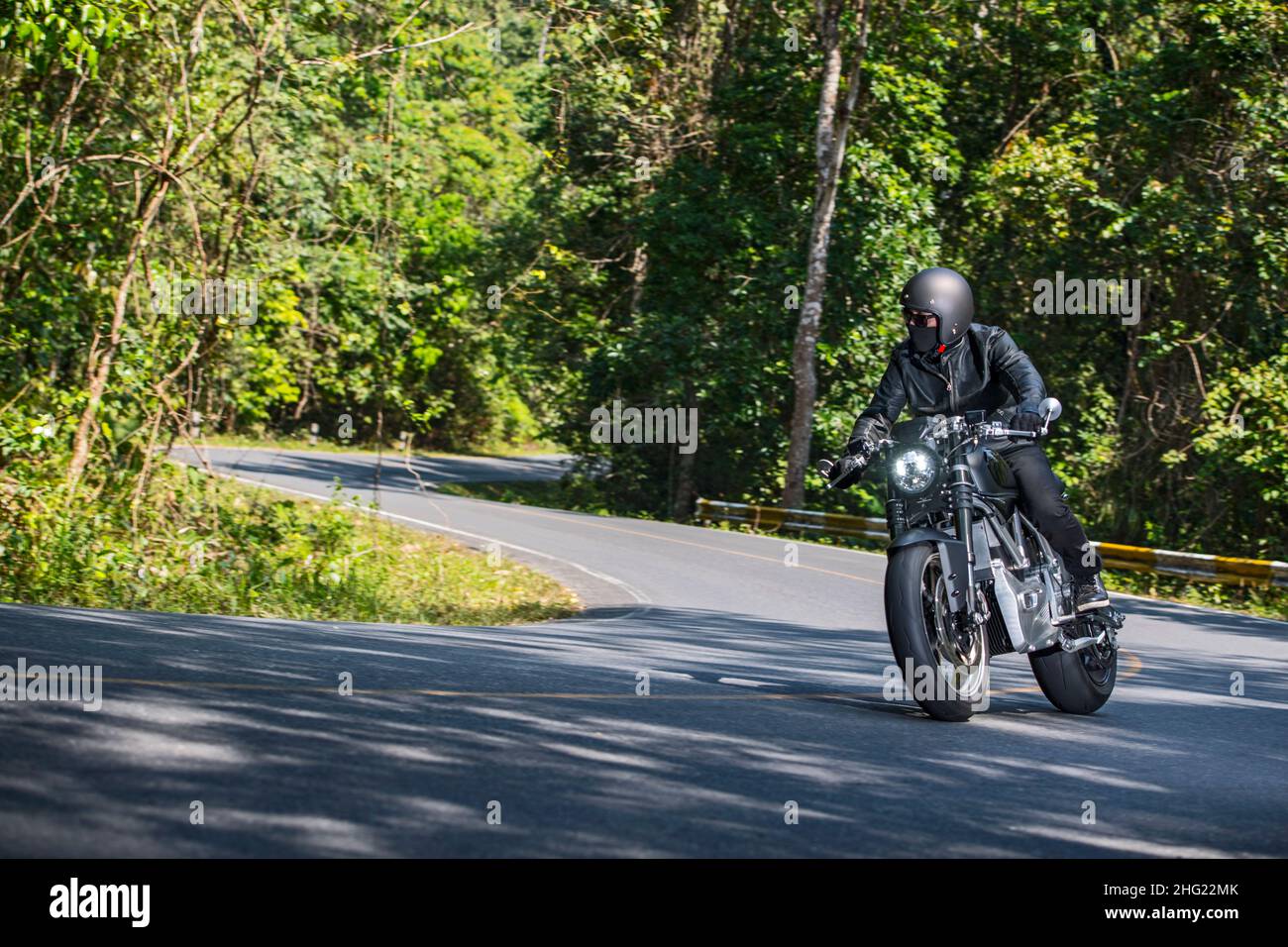 man riding an electric motorcycle in Thailand Stock Photo - Alamy