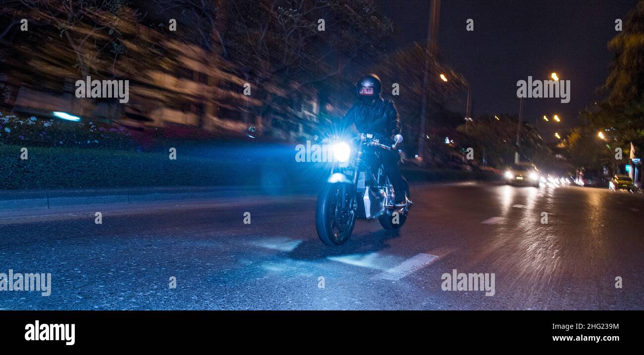 Man riding his electric motorcycle through Bangkok Stock Photo - Alamy