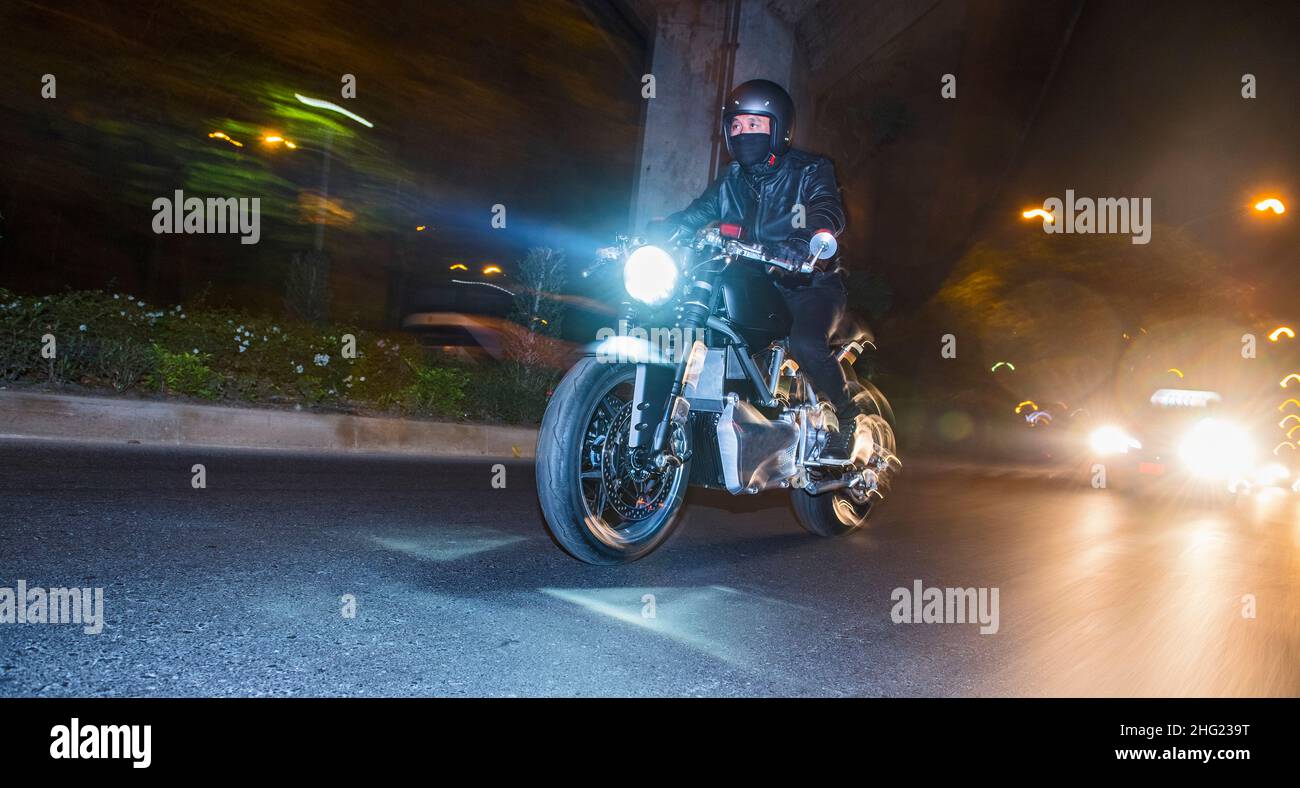 Man riding his electric motorcycle through Bangkok Stock Photo - Alamy