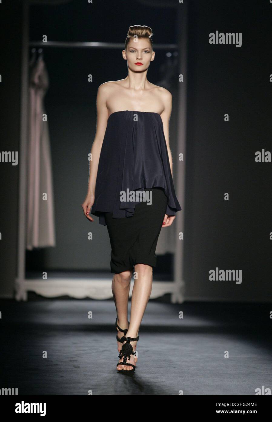 A model on the cat walk wears a design by Moschino during Milan Fashion ...
