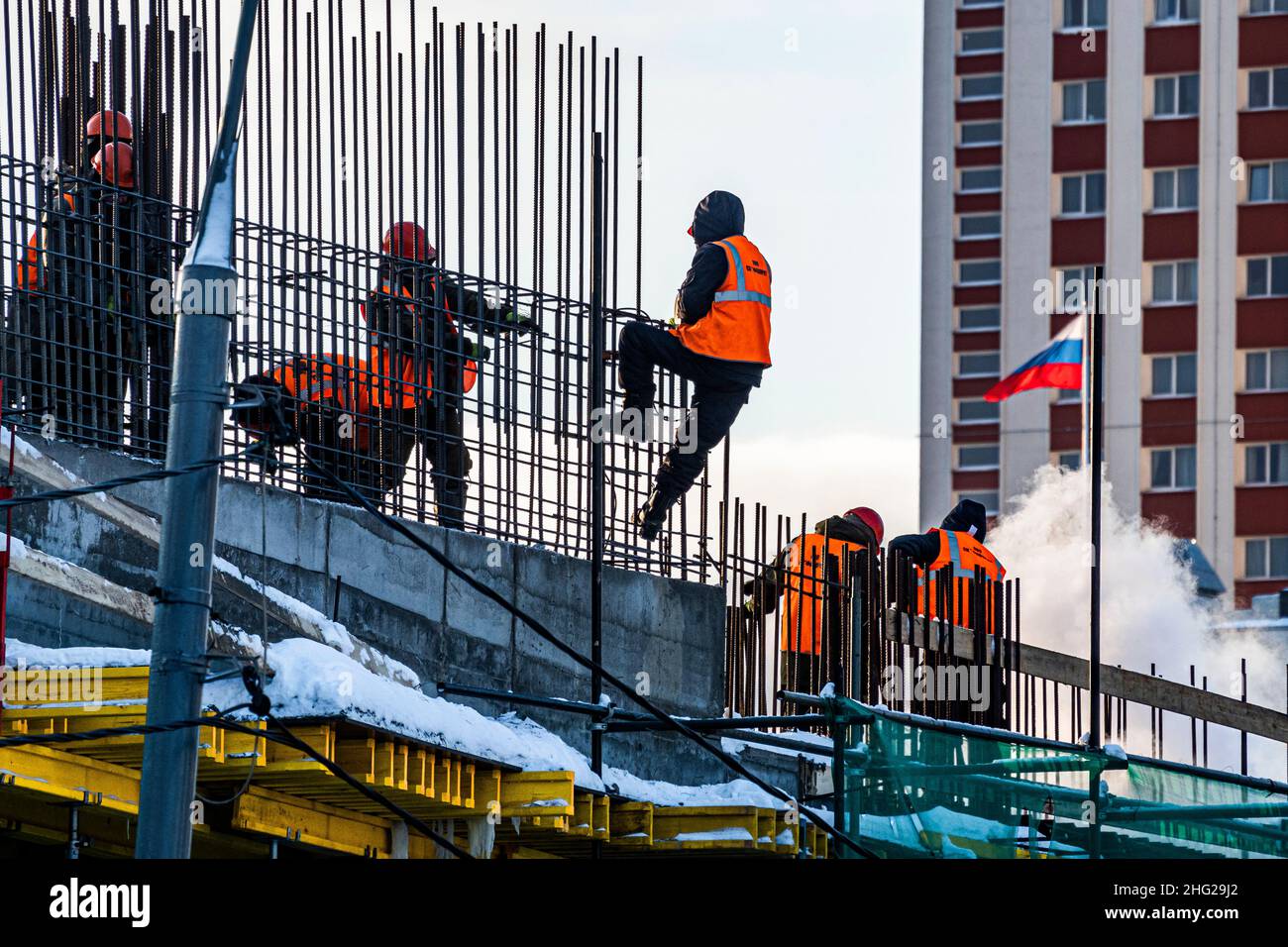 Russia, Moscow. Workers at the construction site of residential complex ...