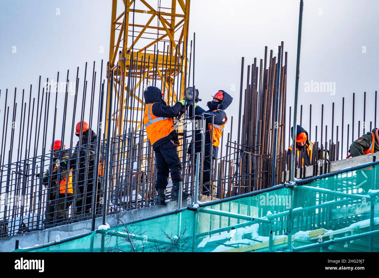Russia, Moscow. Workers at the construction site of residential complex ...