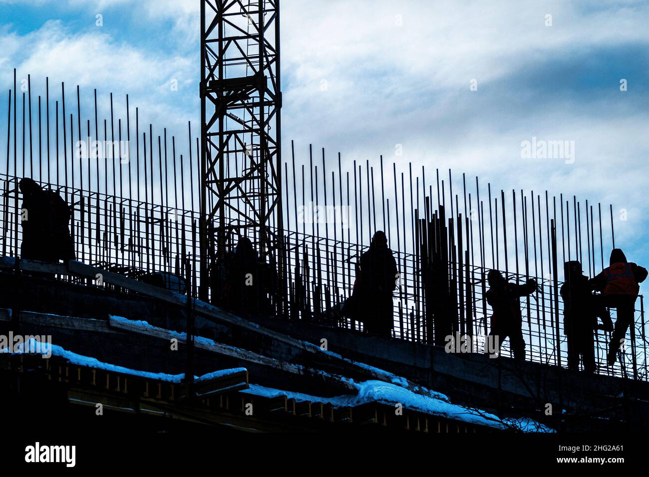 Russia, Moscow. Workers at the construction site of residential complex ...