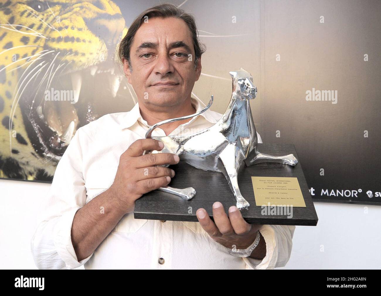 Greek actor Antonis Kafetzopoulos, right, holds the Leopard for best ...