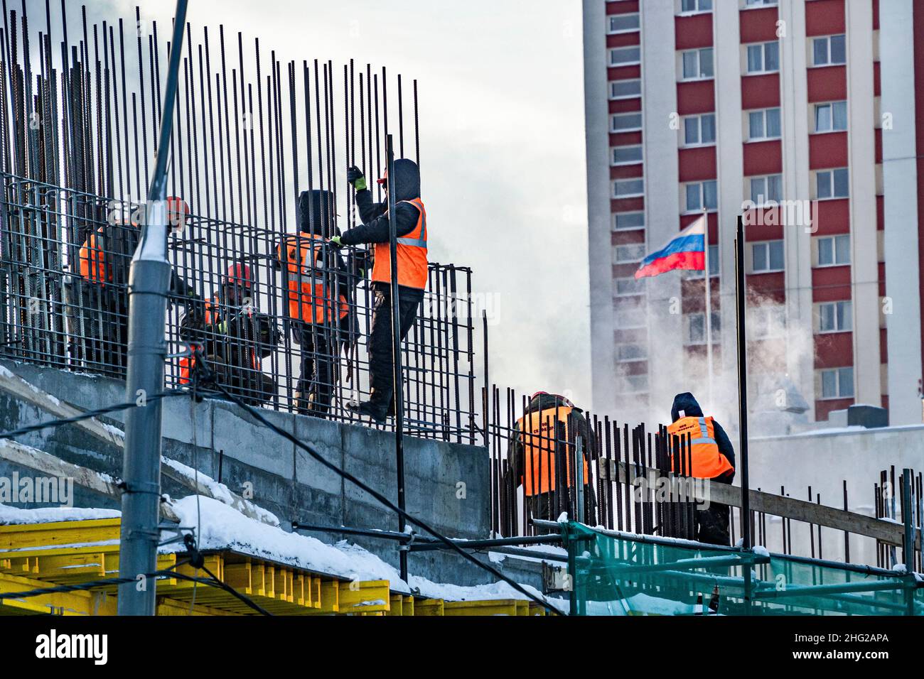 Russia, Moscow. Workers at the construction site of residential complex ...