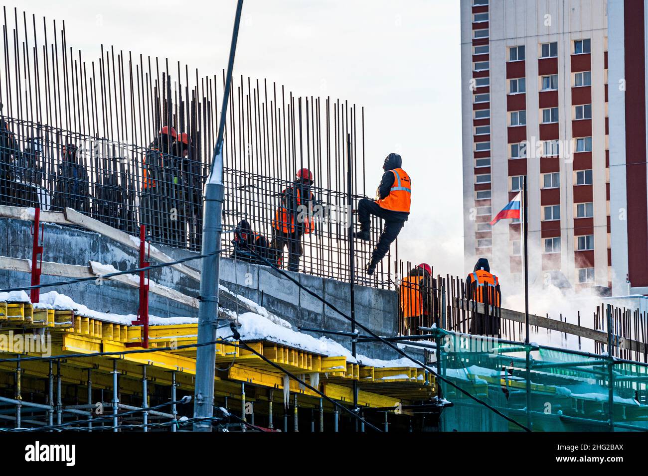 Russia, Moscow. Workers at the construction site of residential complex ...
