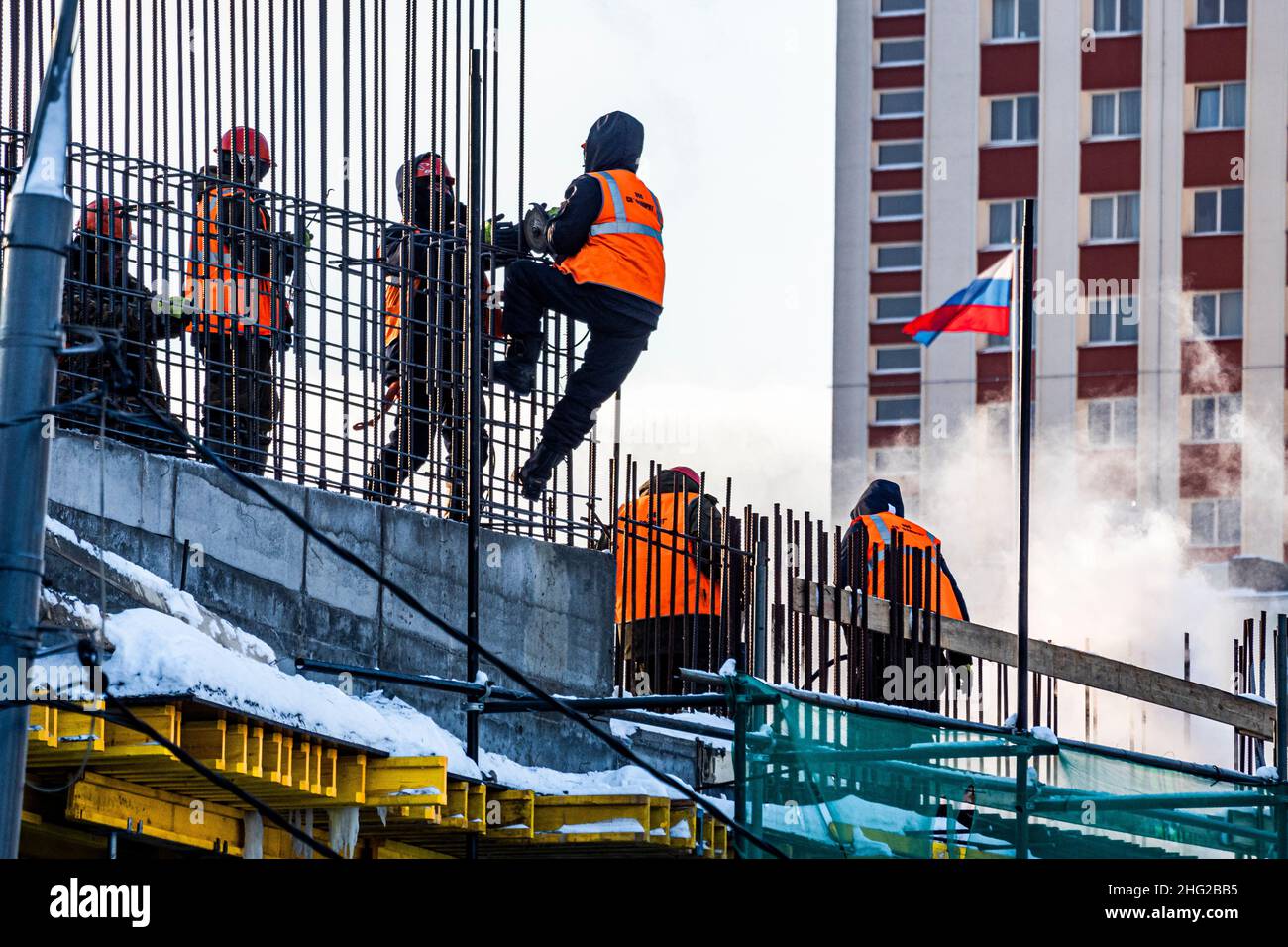 Russia, Moscow. Workers at the construction site of residential complex ...
