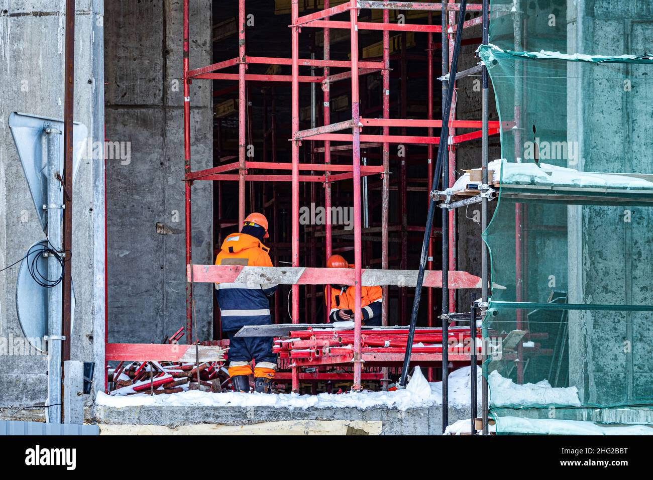 Russia, Moscow. Workers at the construction site of residential complex ...
