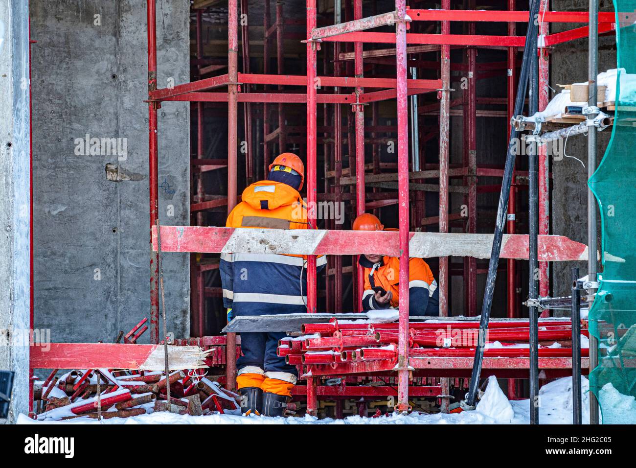 Russia, Moscow. Workers at the construction site of residential complex ...