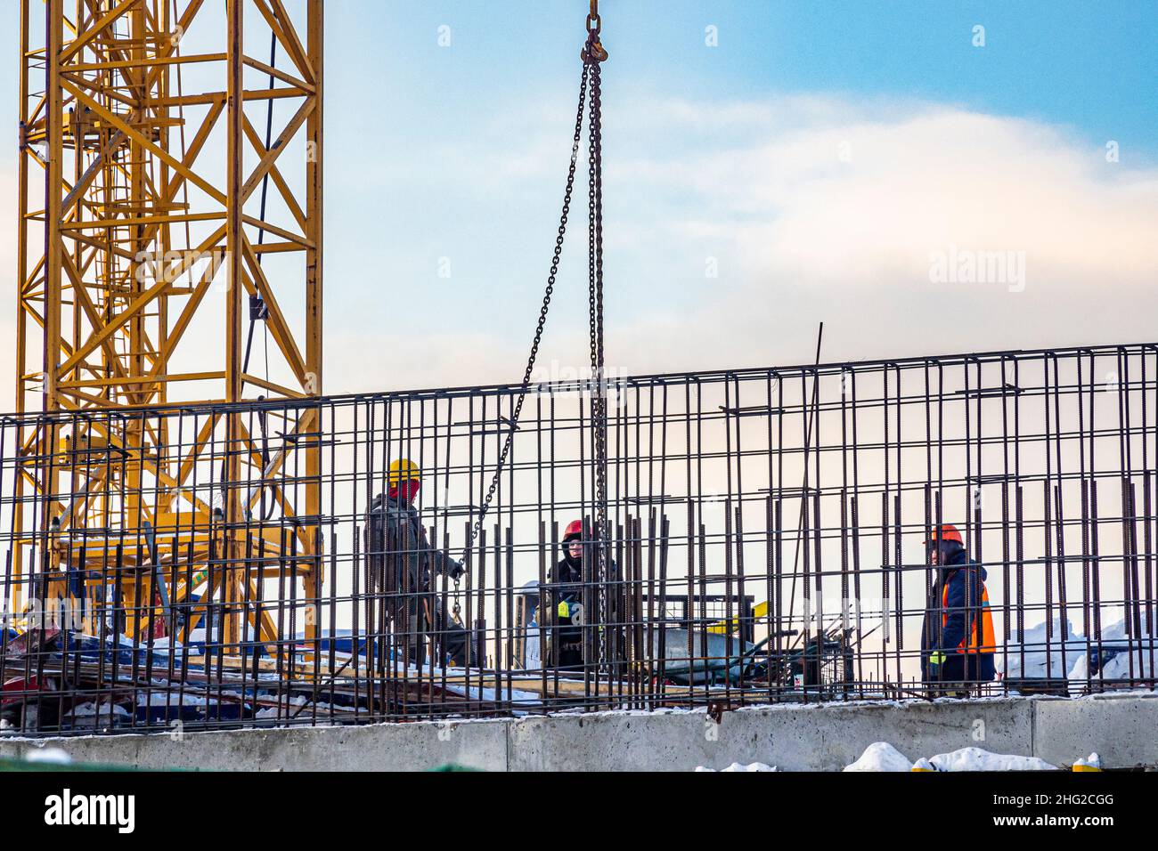Russia, Moscow. Workers at the construction site of residential complex ...