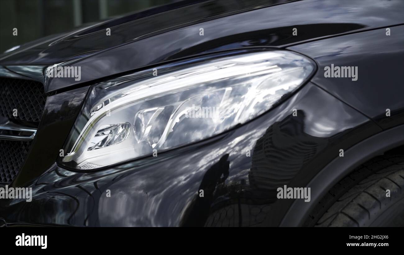 Close up detail for one of the LED headlights of a modern black car ...