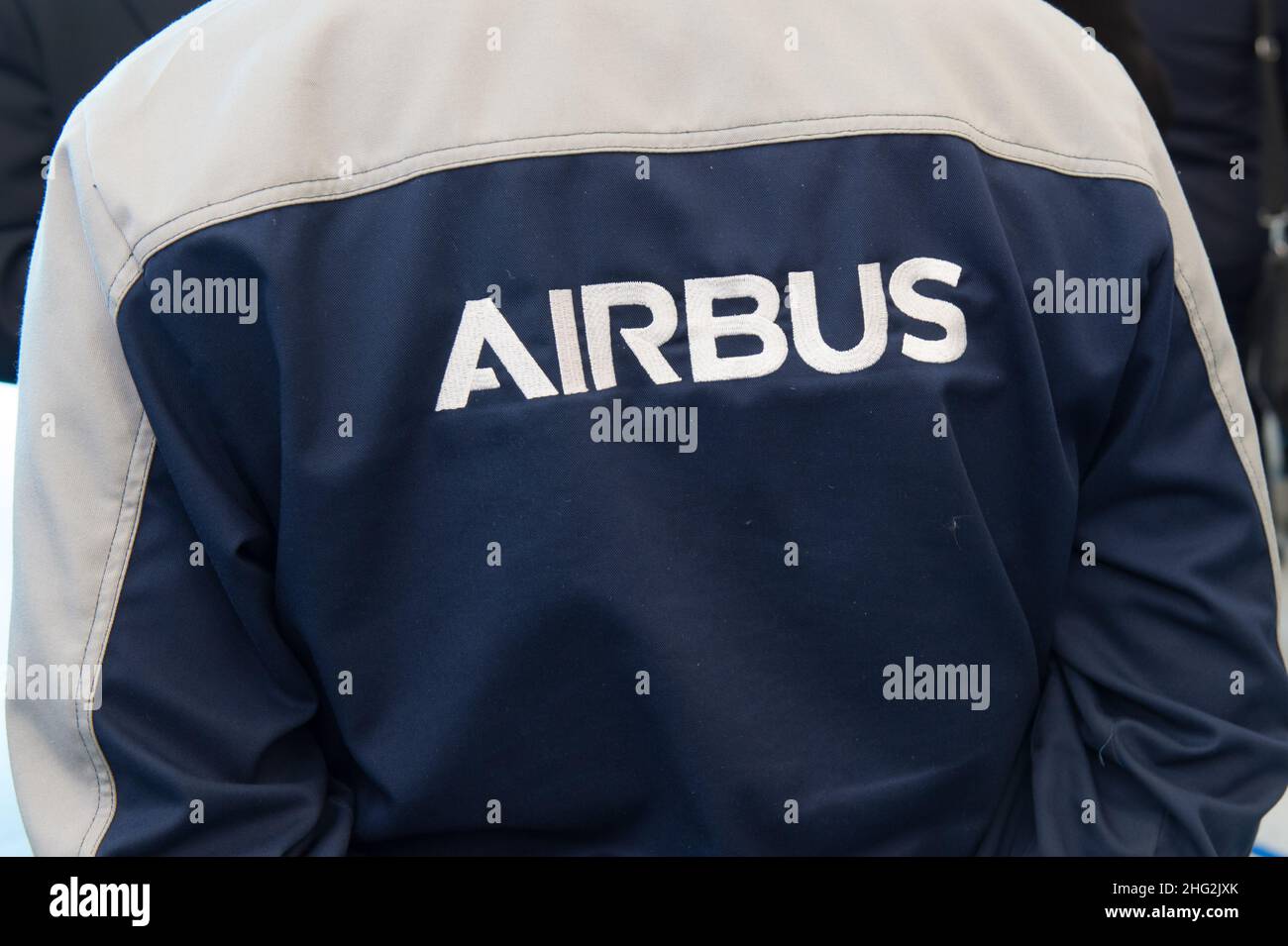 An Airbus worker seen from behind with the name Airbus embroidered on ...