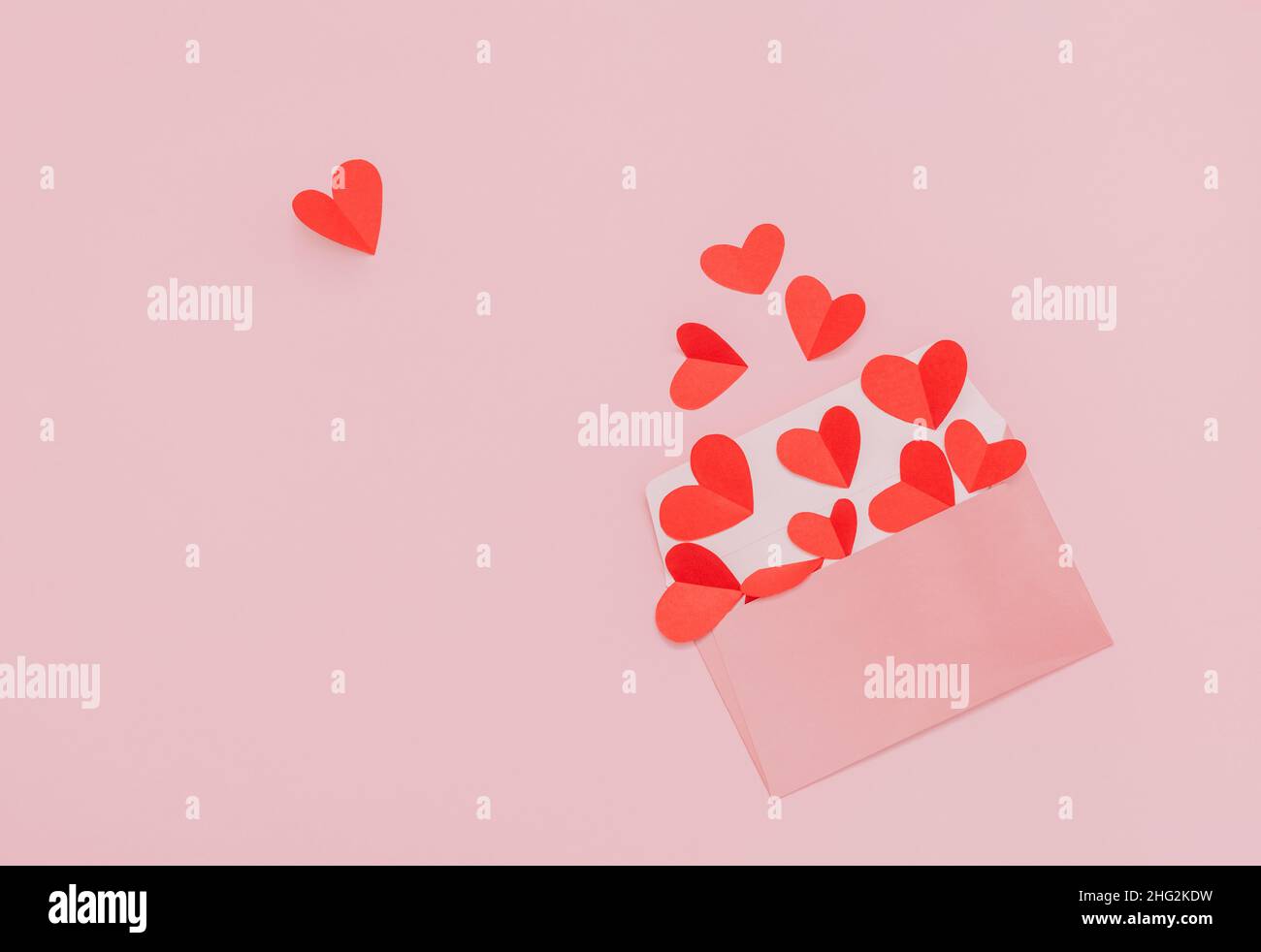 Many red paper hearts falling out of the envelope Stock Photo - Alamy