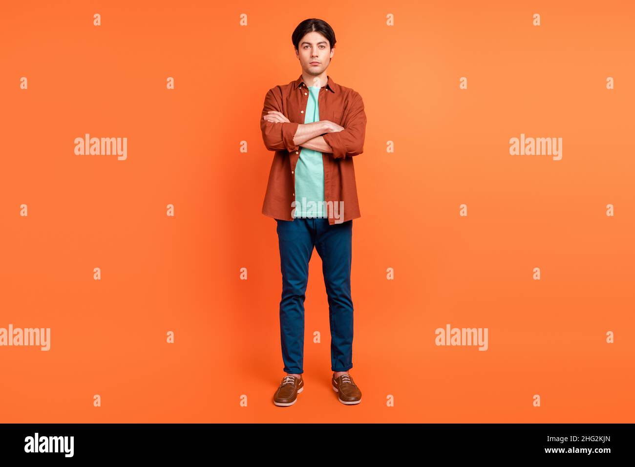 Full size photo of young cool confident businessman with folded hands ...