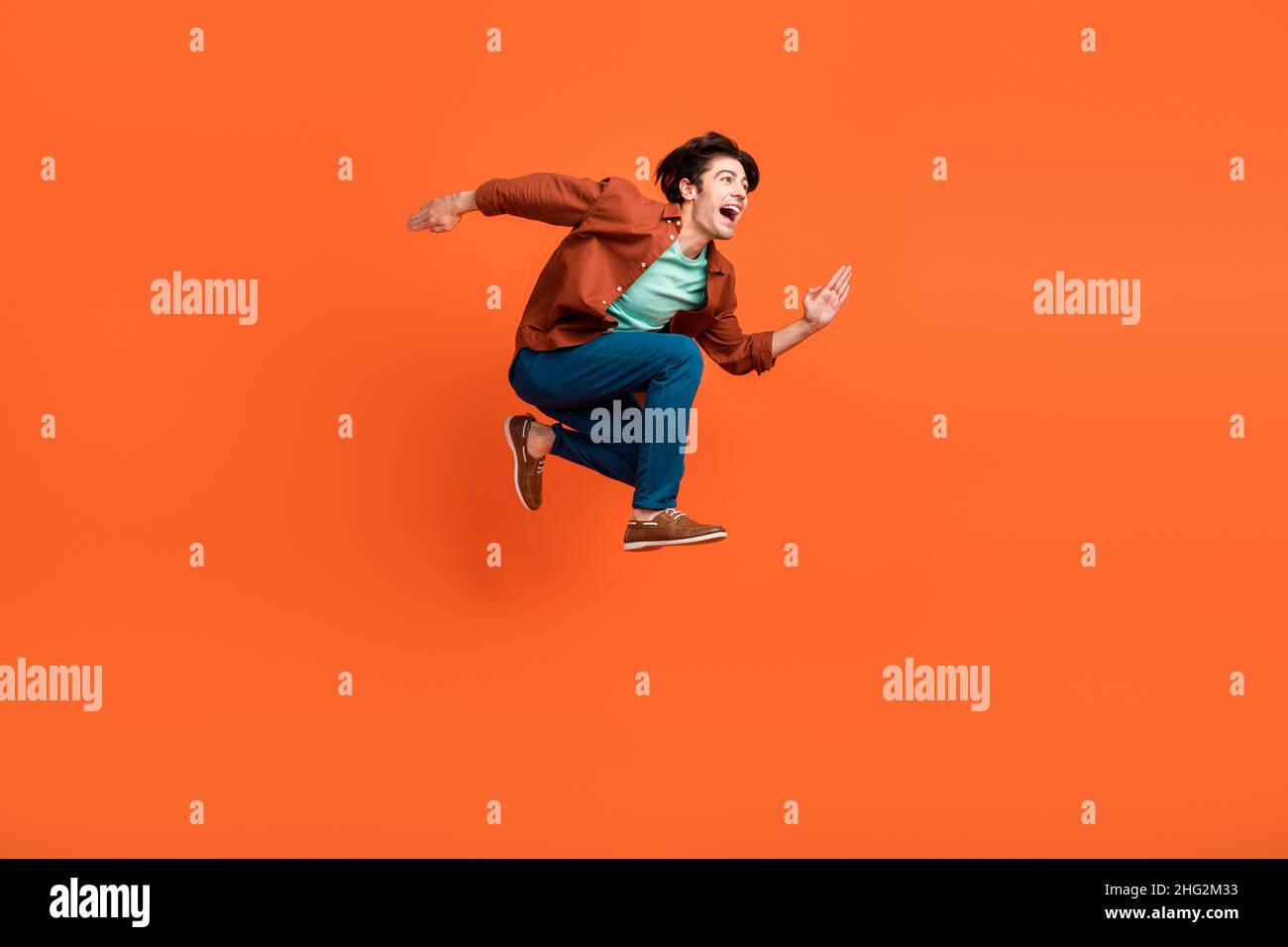 Full size profile side photo of happy funky man running in air look ...